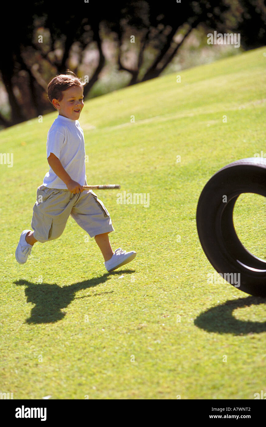 Boy rolling tire hi-res stock photography and images - Alamy