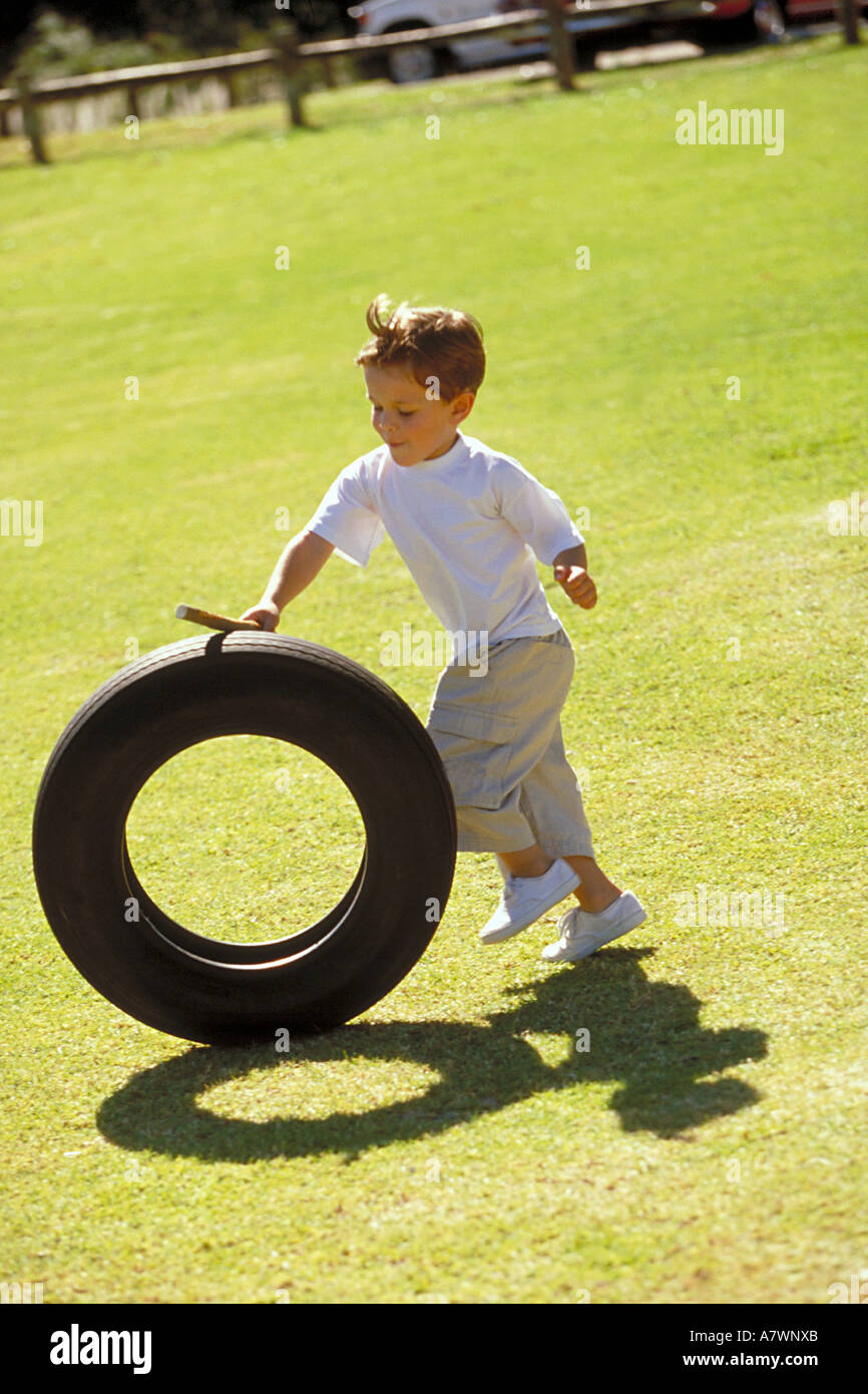 Boy rolling tire hi-res stock photography and images - Alamy
