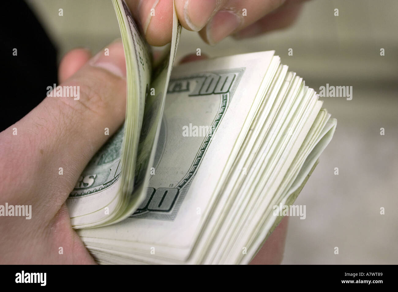 details of hand and fingers of man counting bundle of one hundred ...