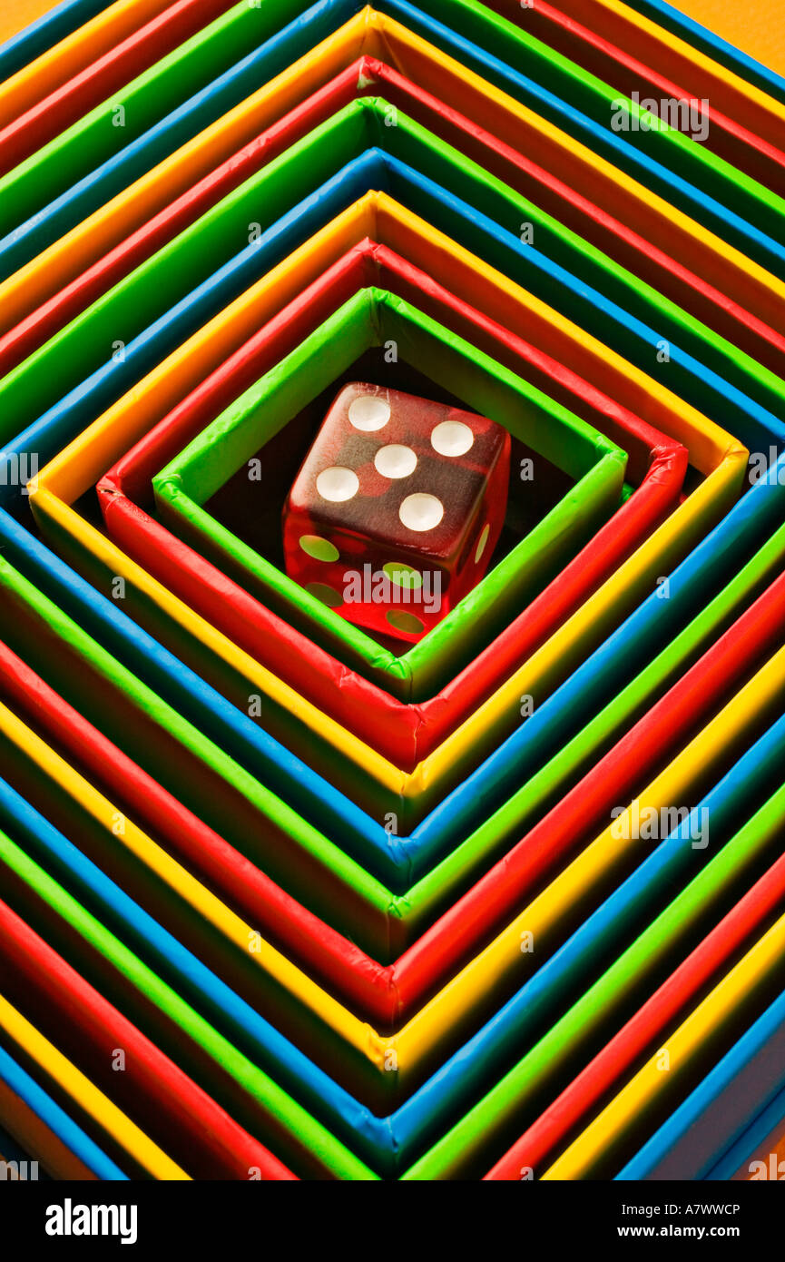 Red dice in colorful box, boxes Stock Photo - Alamy