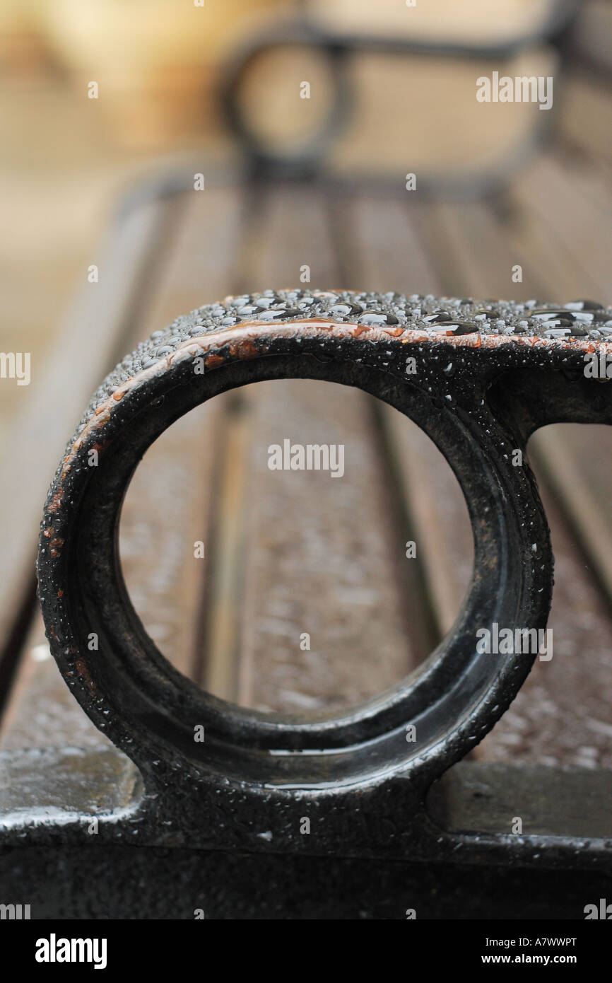 Bench seat in the rain with wet rain drops on arm rest Stock Photo - Alamy