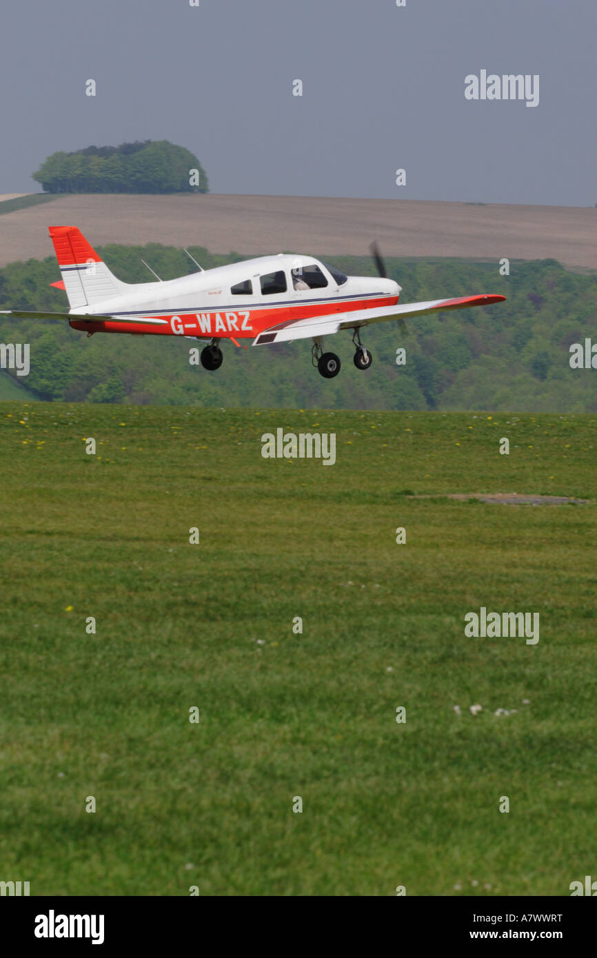 Piper Pa 28 Cherokee basic flight trainer landing at a grass airfield ...