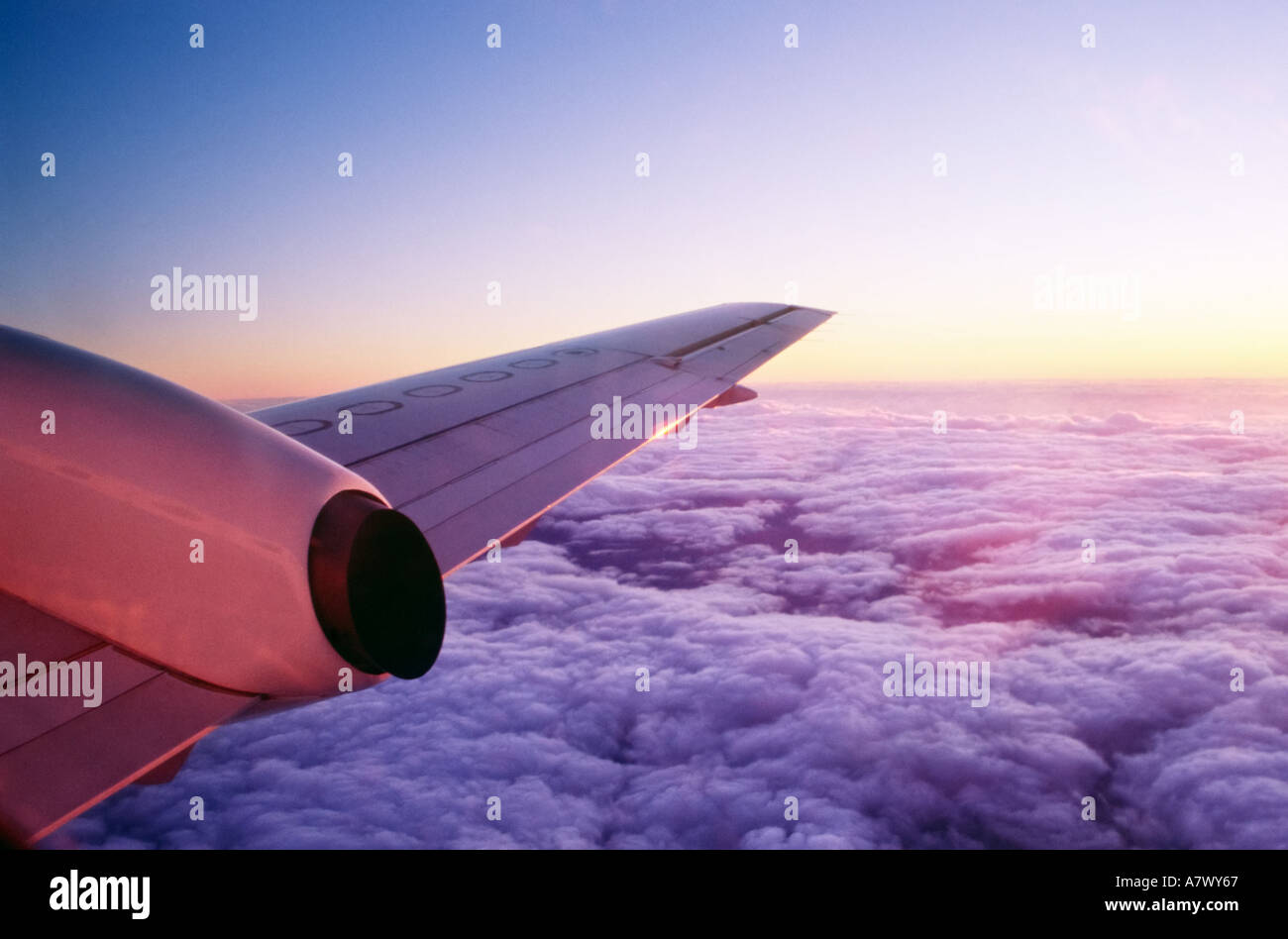 Airplane flying over pink clouds hi-res stock photography and images - Alamy