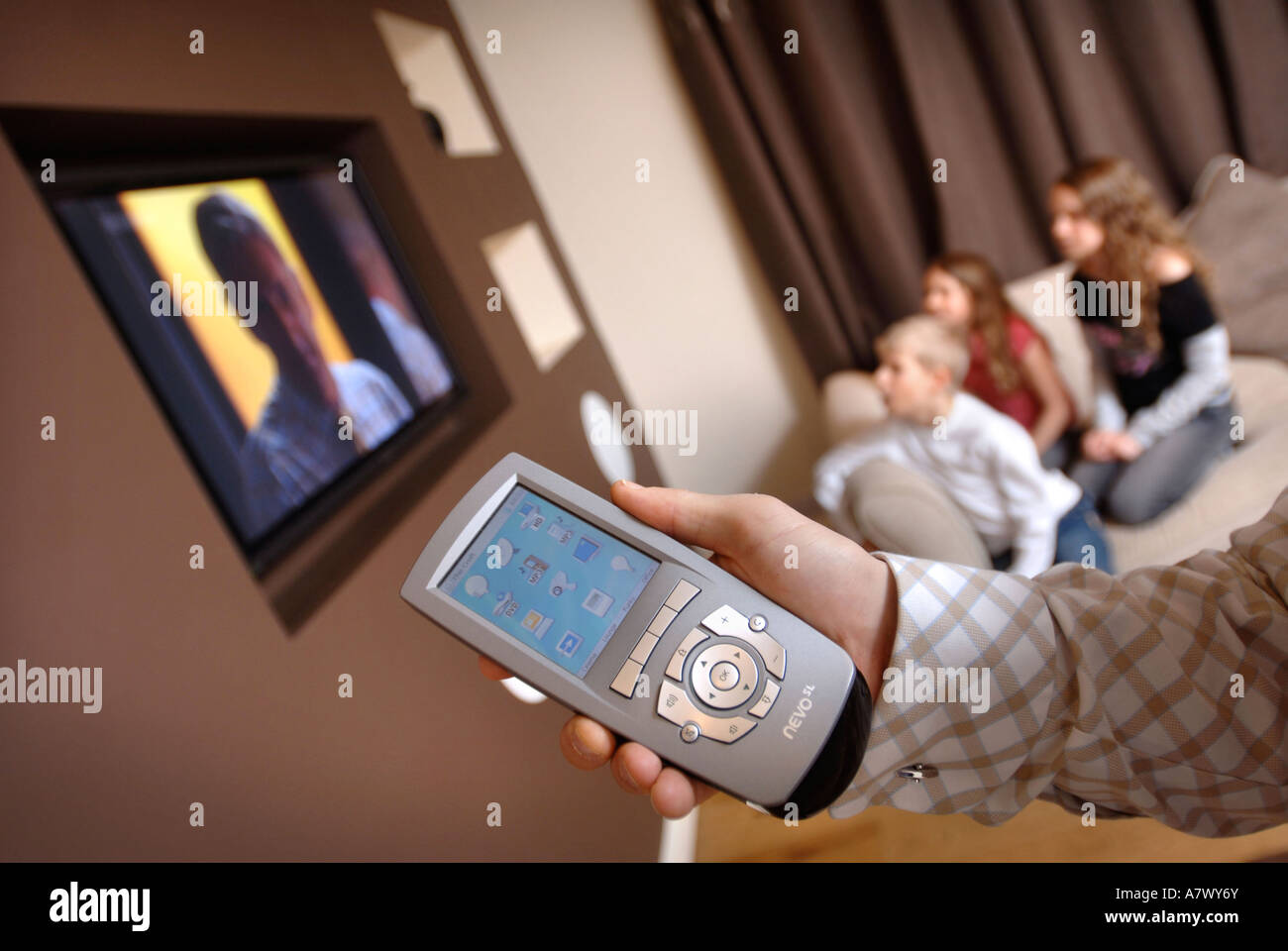 A REMOTE CONTROL AIMED AT A CONTROL PANEL IN A SMART HOUSE Stock Photo ...
