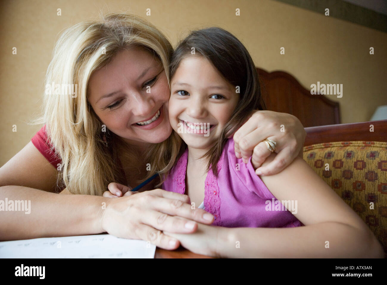 hispanic seven year old girl working on math problems with mother Stock ...