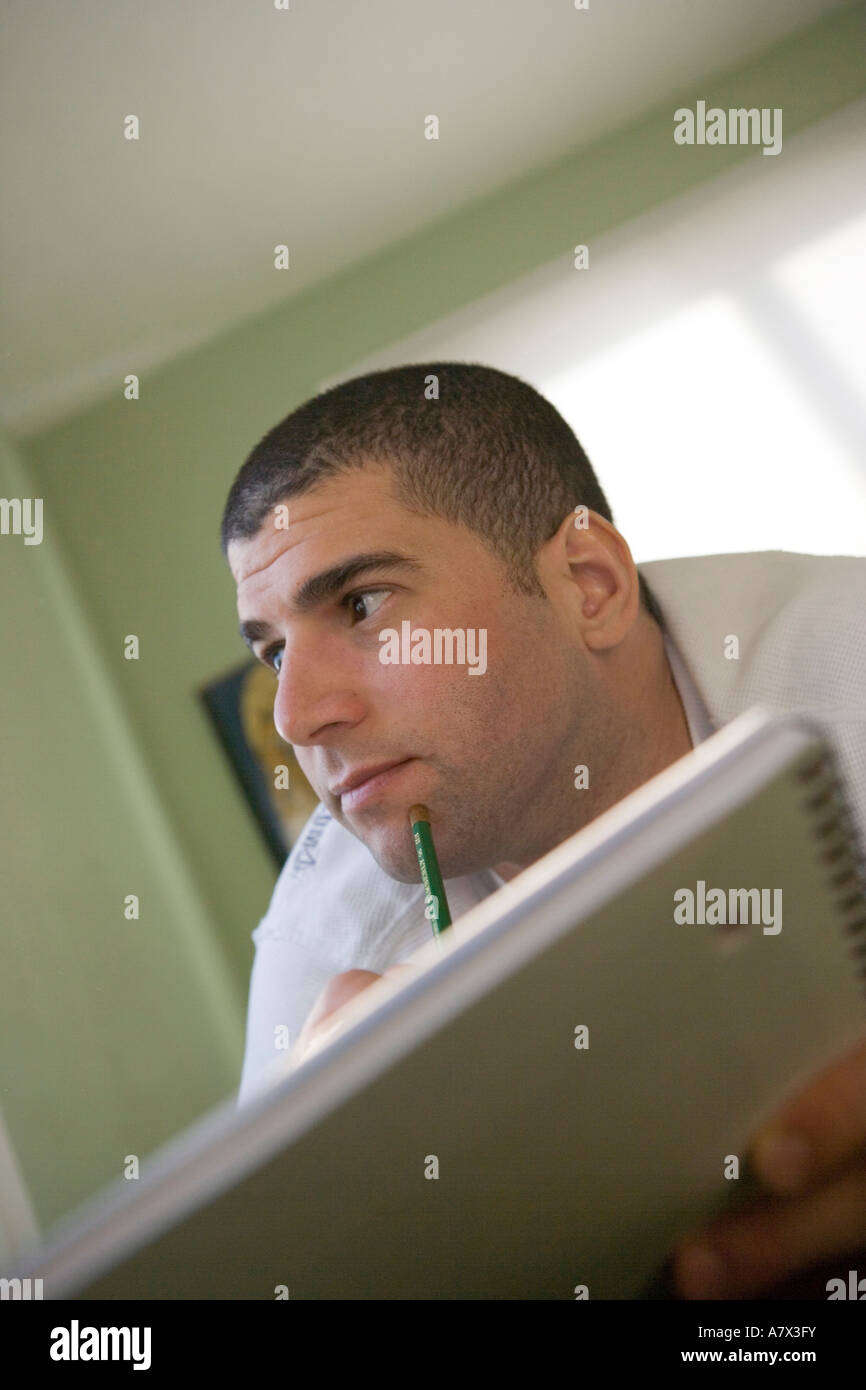 man thinking about what to write with notebook Stock Photo - Alamy