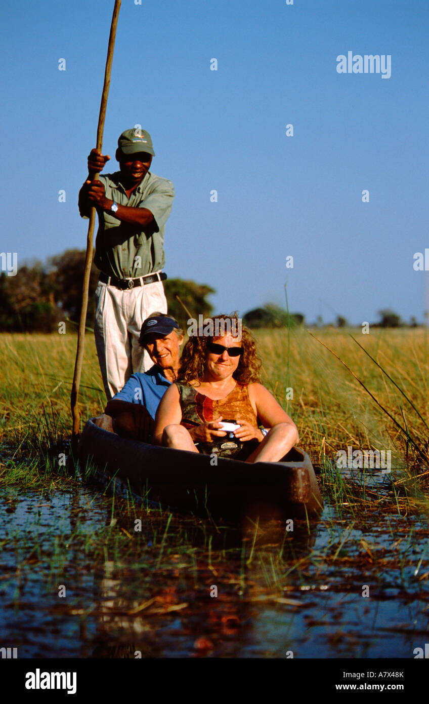 Africa, Botswana, Okavango Delta. Typical mokoro boat traveling the ...