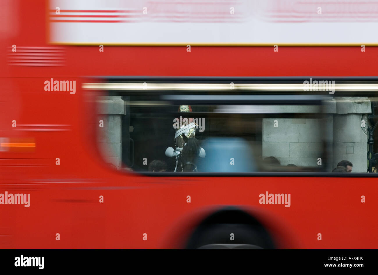 London England. Red London Bus passes mounted Guardsman at Horse ...