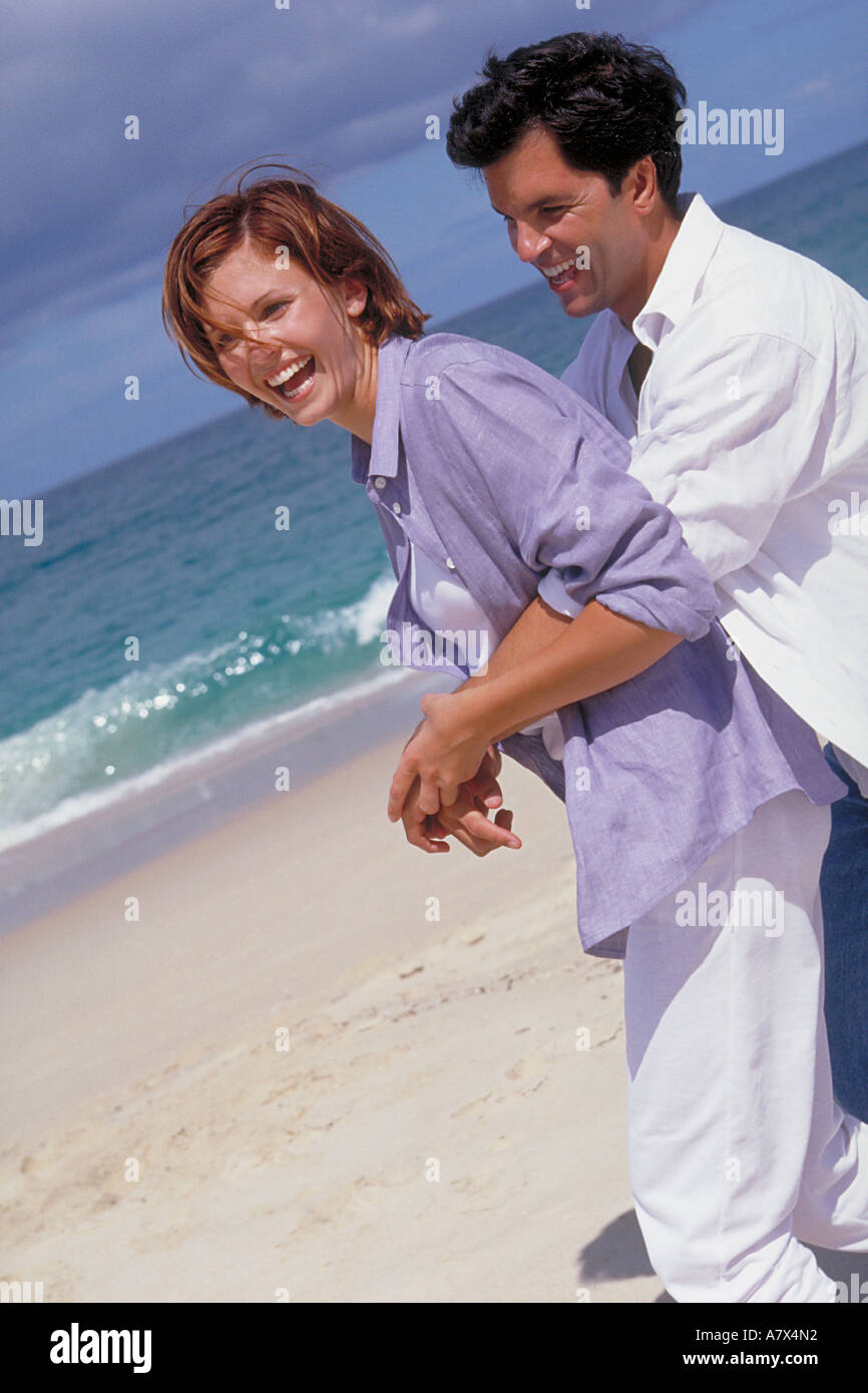 Couple embracing on beach waves hi-res stock photography and images - Alamy