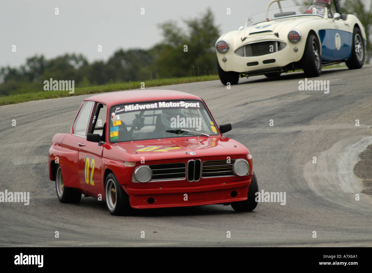 Alex Rorke in his 1971 BMW 2002 followed by Mike Fisher in his 1960 ...