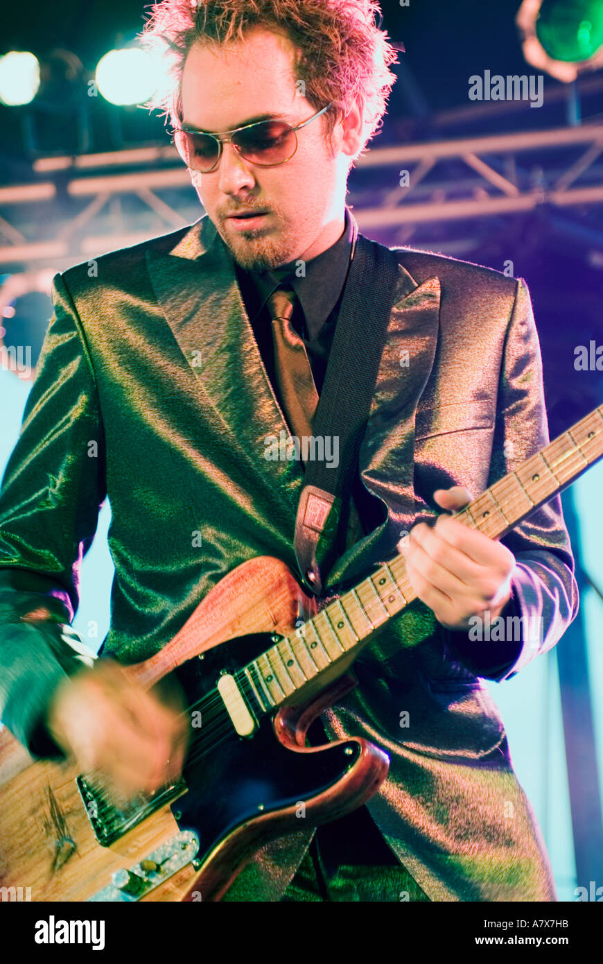 Celebrity music performing guitar on stage playing instrument hi-res ...