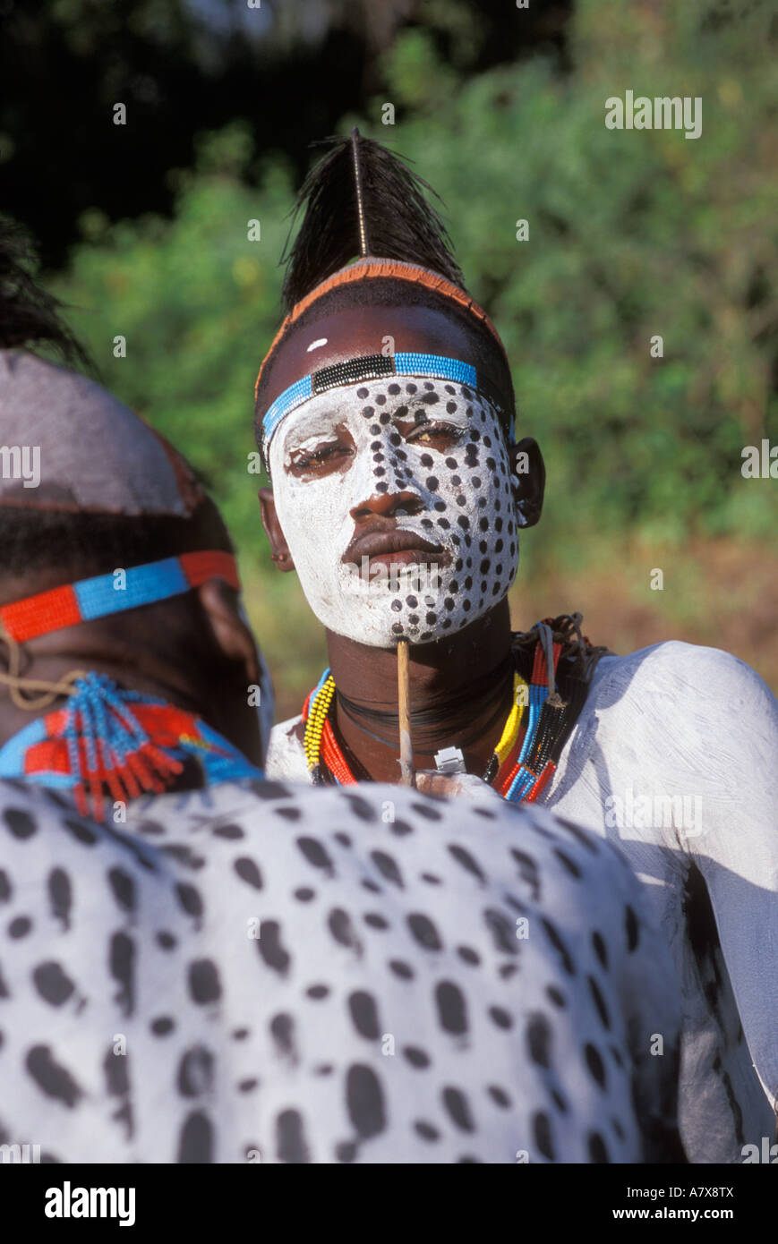 A Karo warrior puts body paint on another Karo man, in Ethiopia's Omo ...