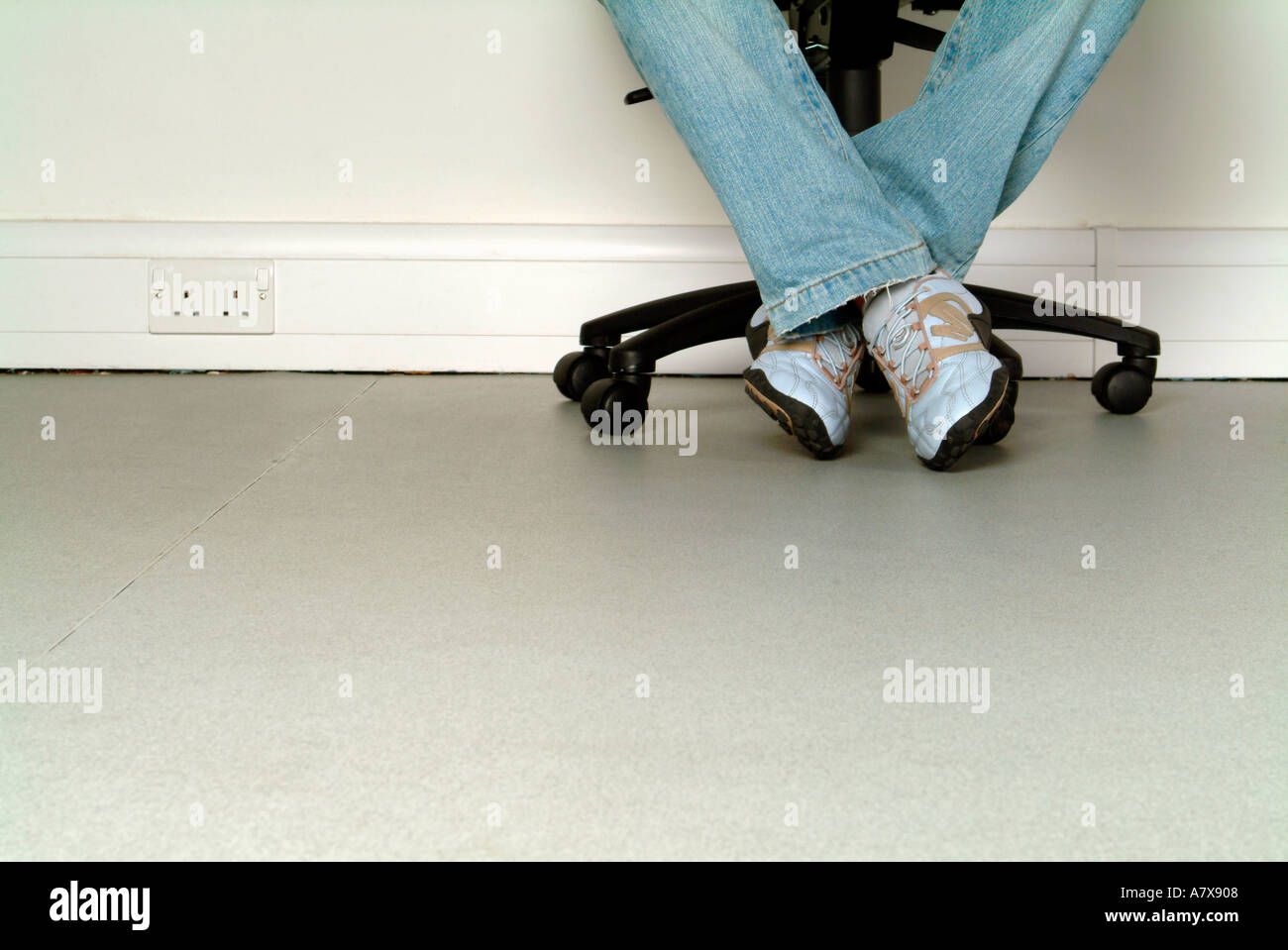 Feet on an office chair Stock Photo - Alamy