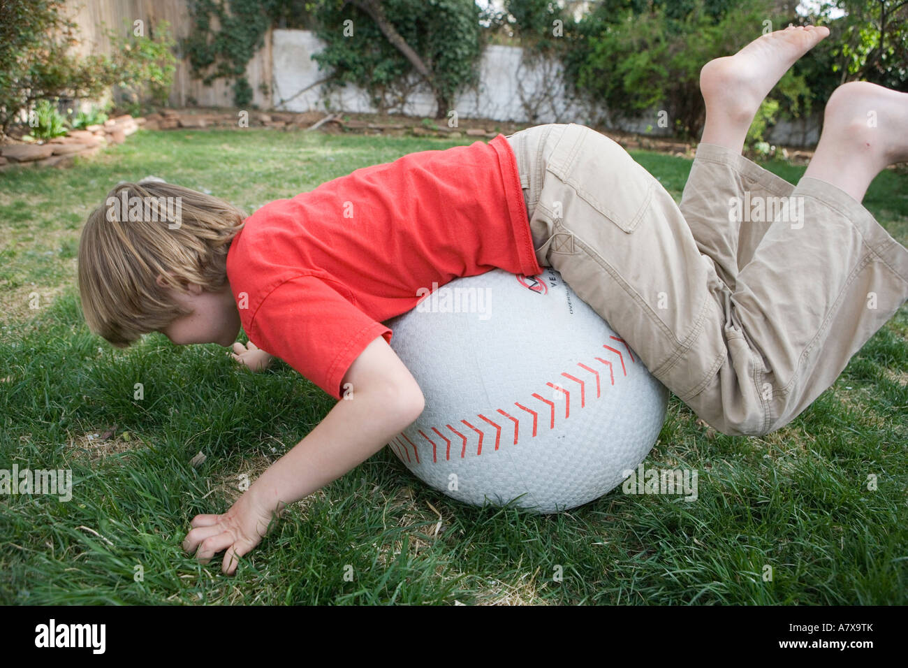 child balancing on large rubber ball Stock Photo - Alamy