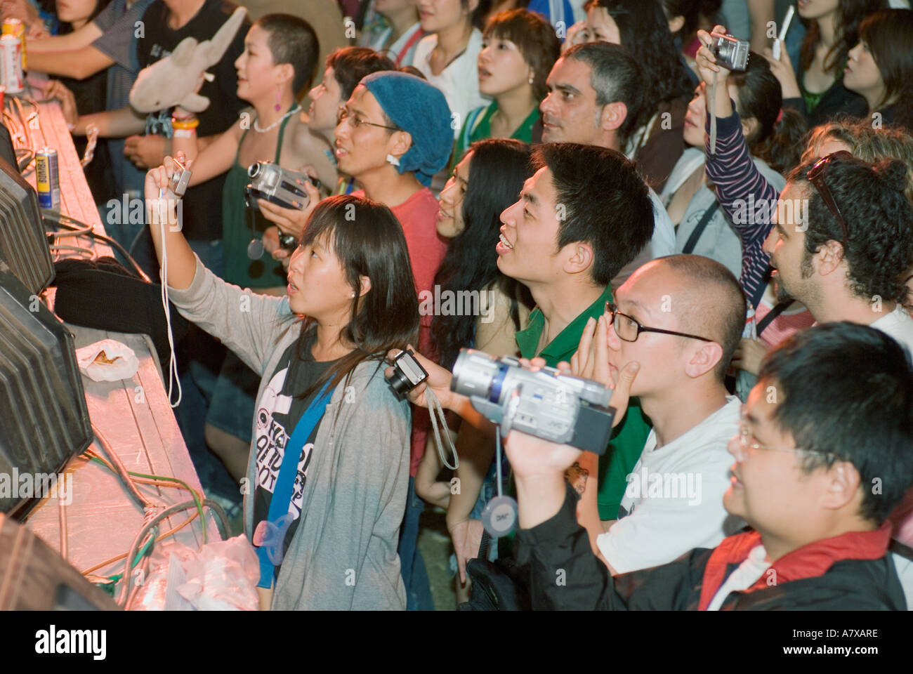Multiethnic crowd listening to and watching live music concert Taiwan China Kenting Spring ...