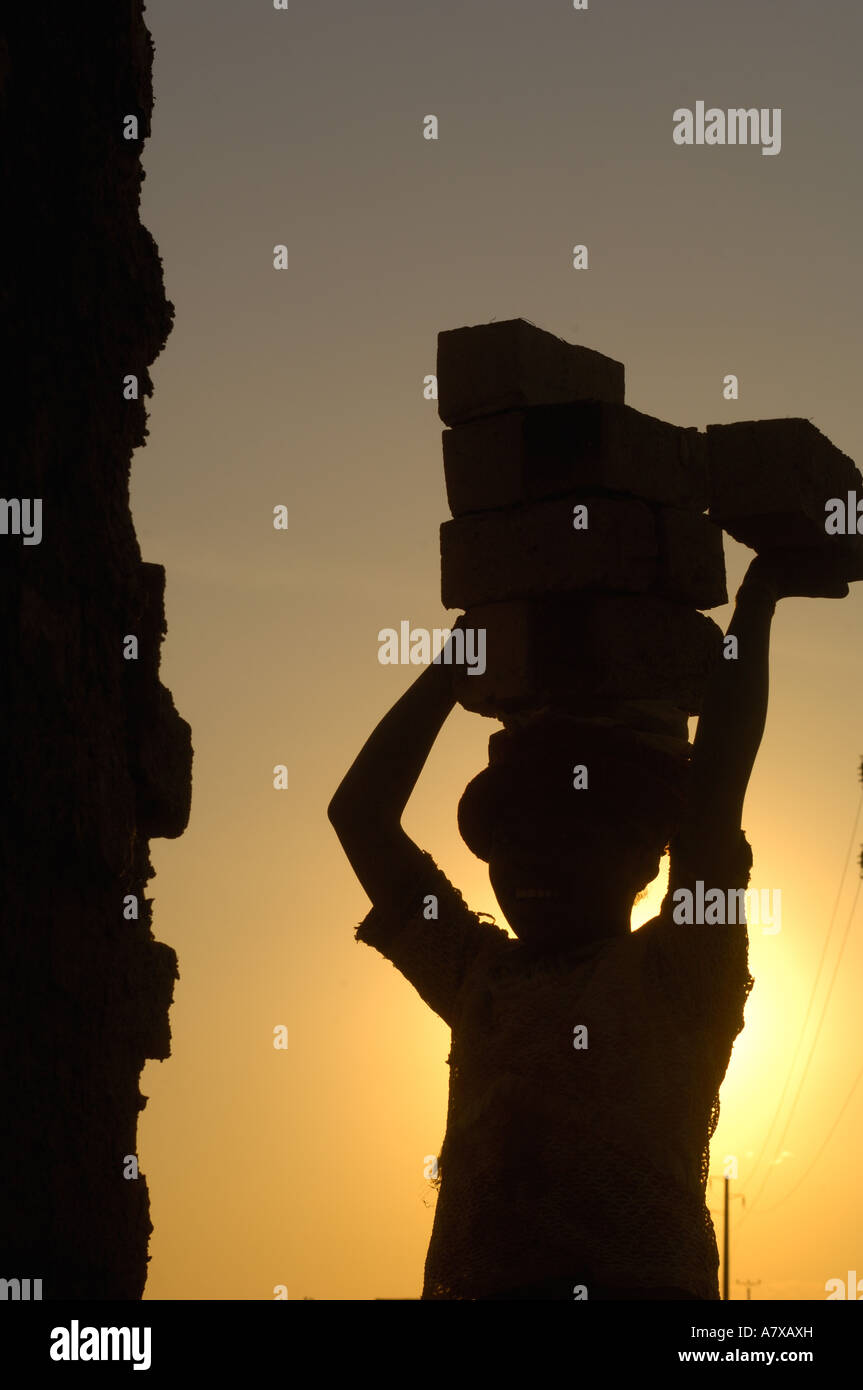 Child carrying bricks. In areas of Madagascar where the soil is ...