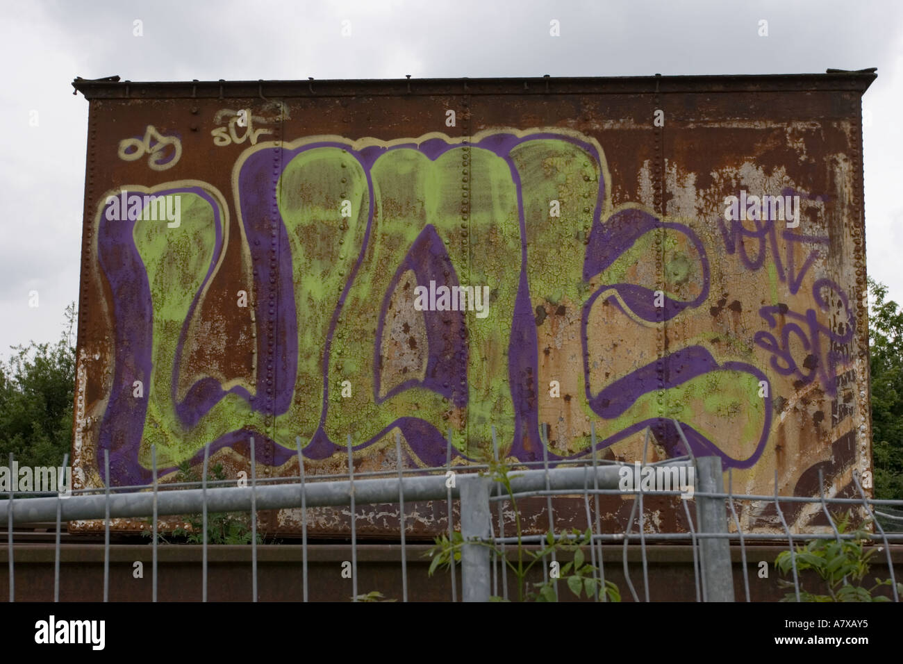Rusty water tank covered in graffiti Stock Photo - Alamy