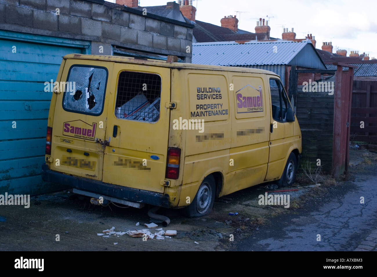 Builder's van abandoned and vandalised in a back alley Stock Photo - Alamy
