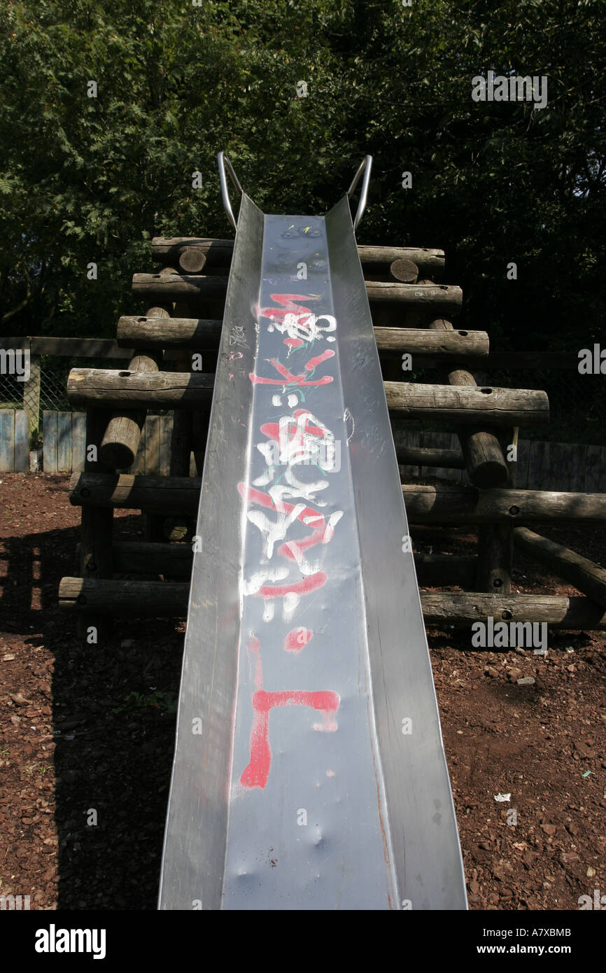 Vandalised and graffitied slide in children's play park Stock Photo - Alamy