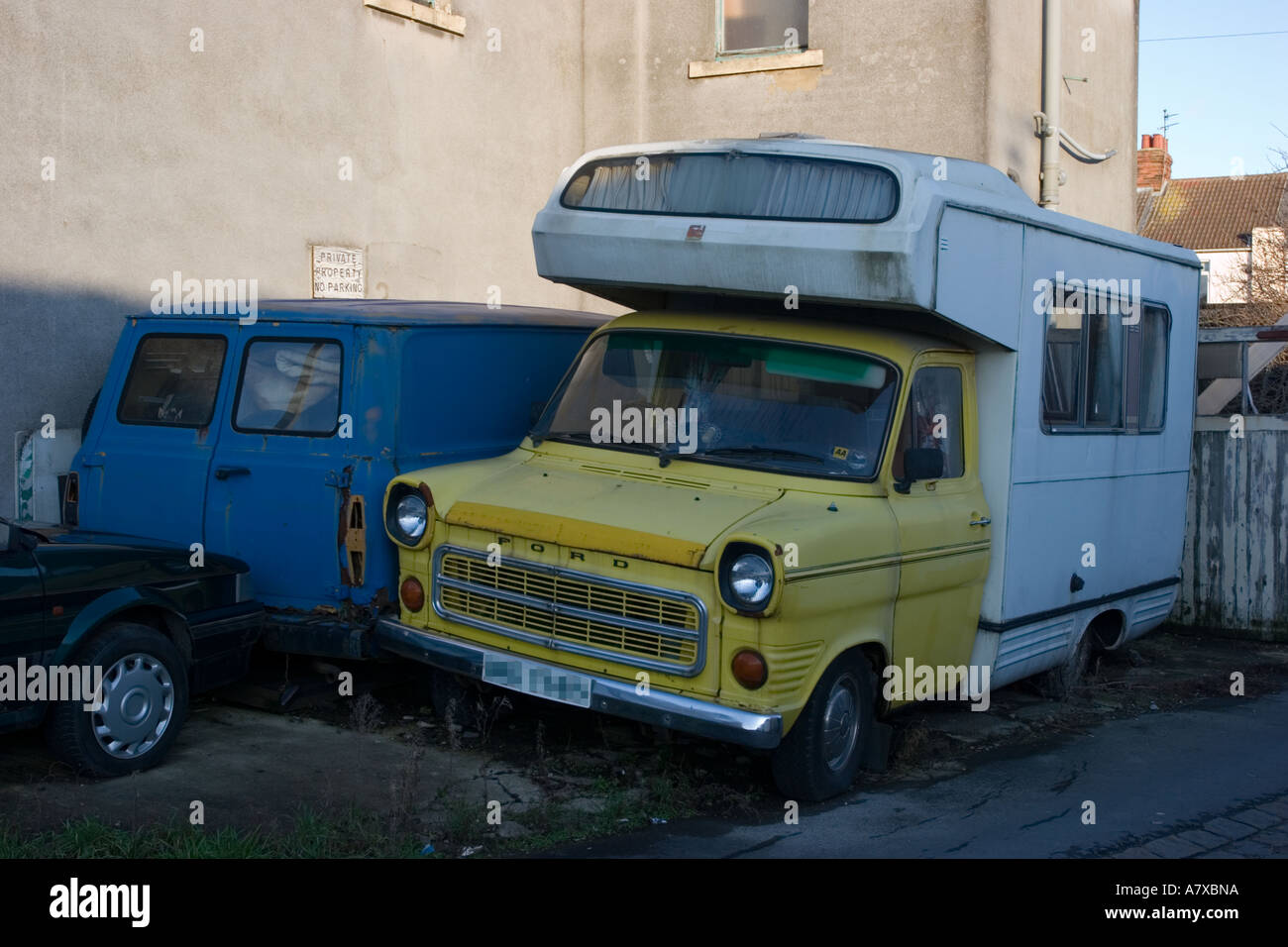 Ancient camper van parked in back alley Stock Photo - Alamy
