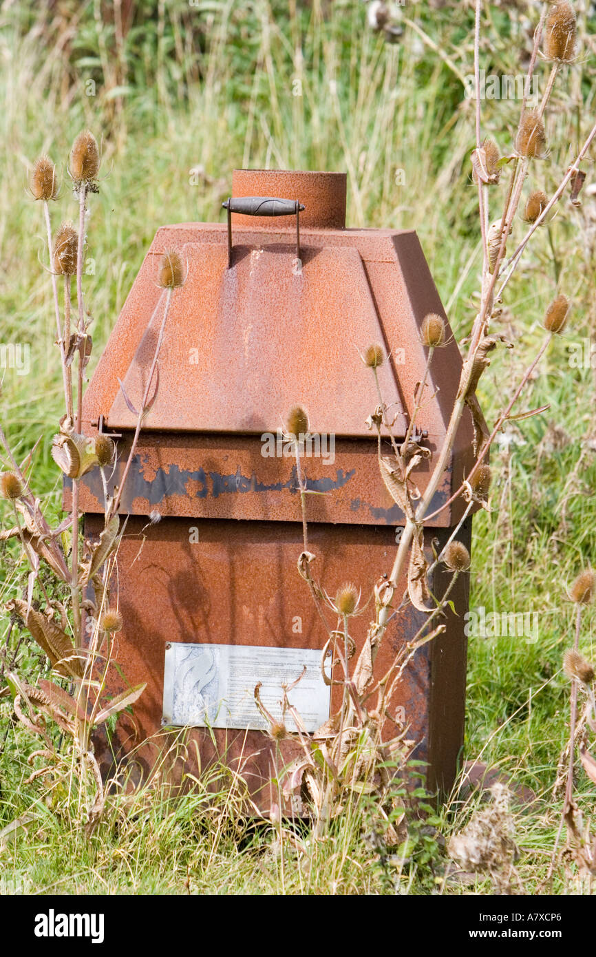 Rusty old boiler in field surrounded by grass and teasels Stock Photo ...