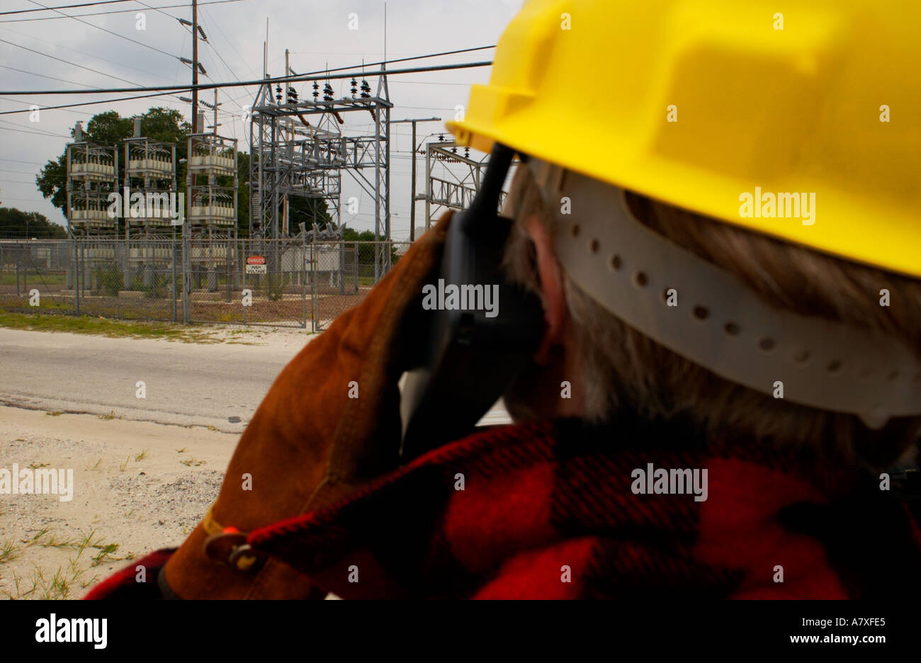 building contractor with cell phone at a power company substation Stock ...