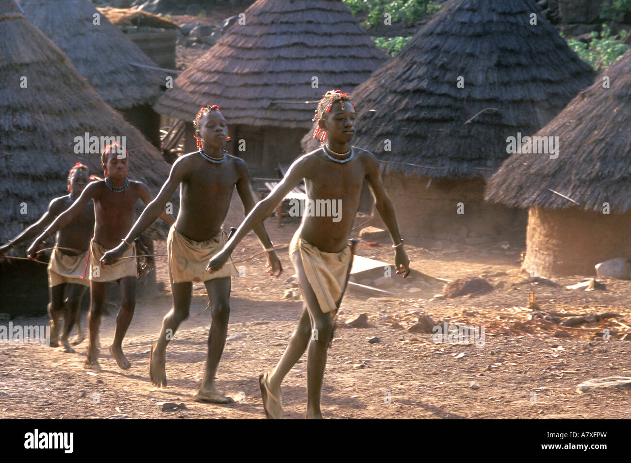 Bedik tribe boys running though their village of Iwol, Senegal as part ...