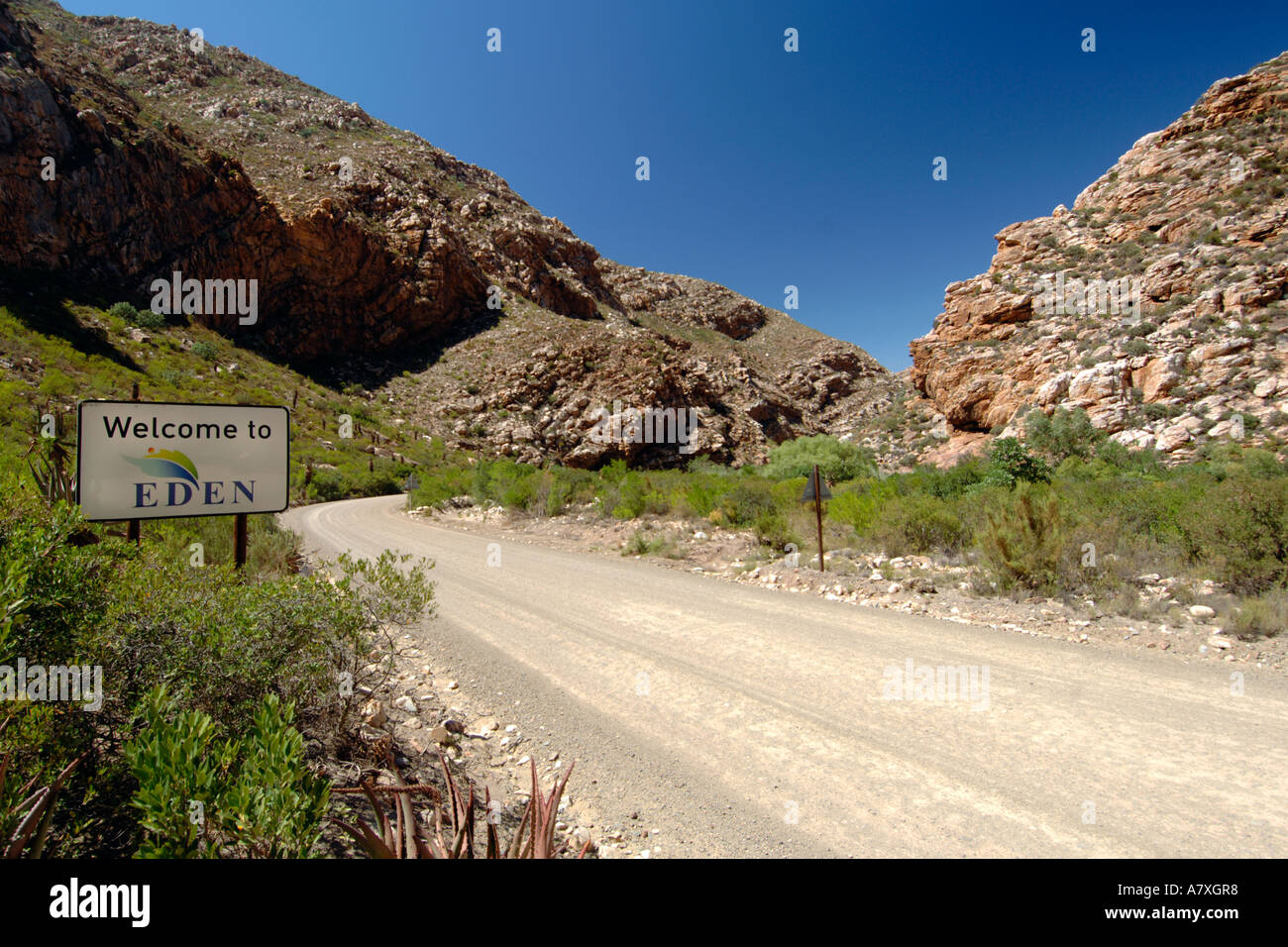 A gravel road leading through the Groot Swartberge mountain range in ...