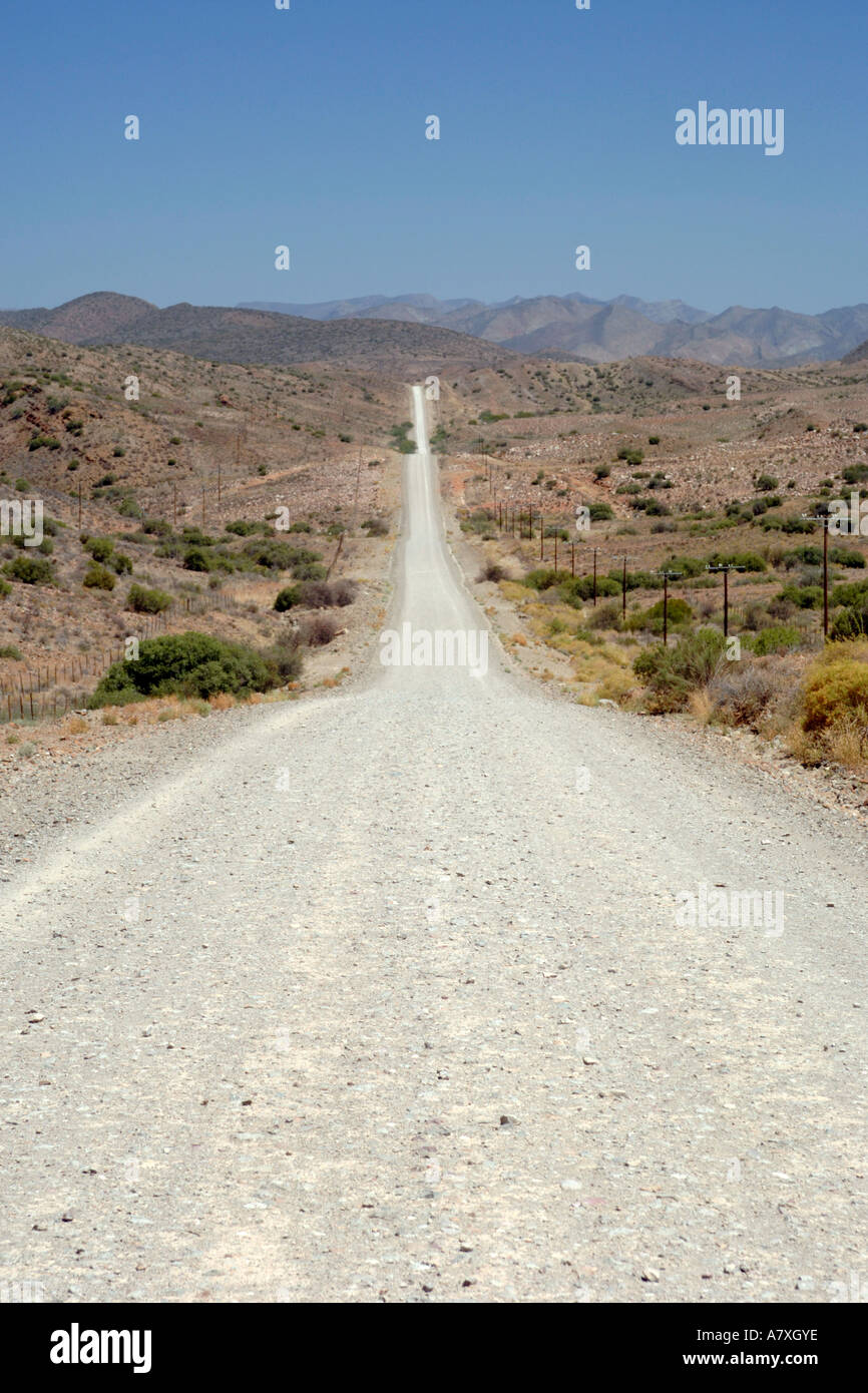 A gravel road leading through the Groot Swartberge mountain range in ...