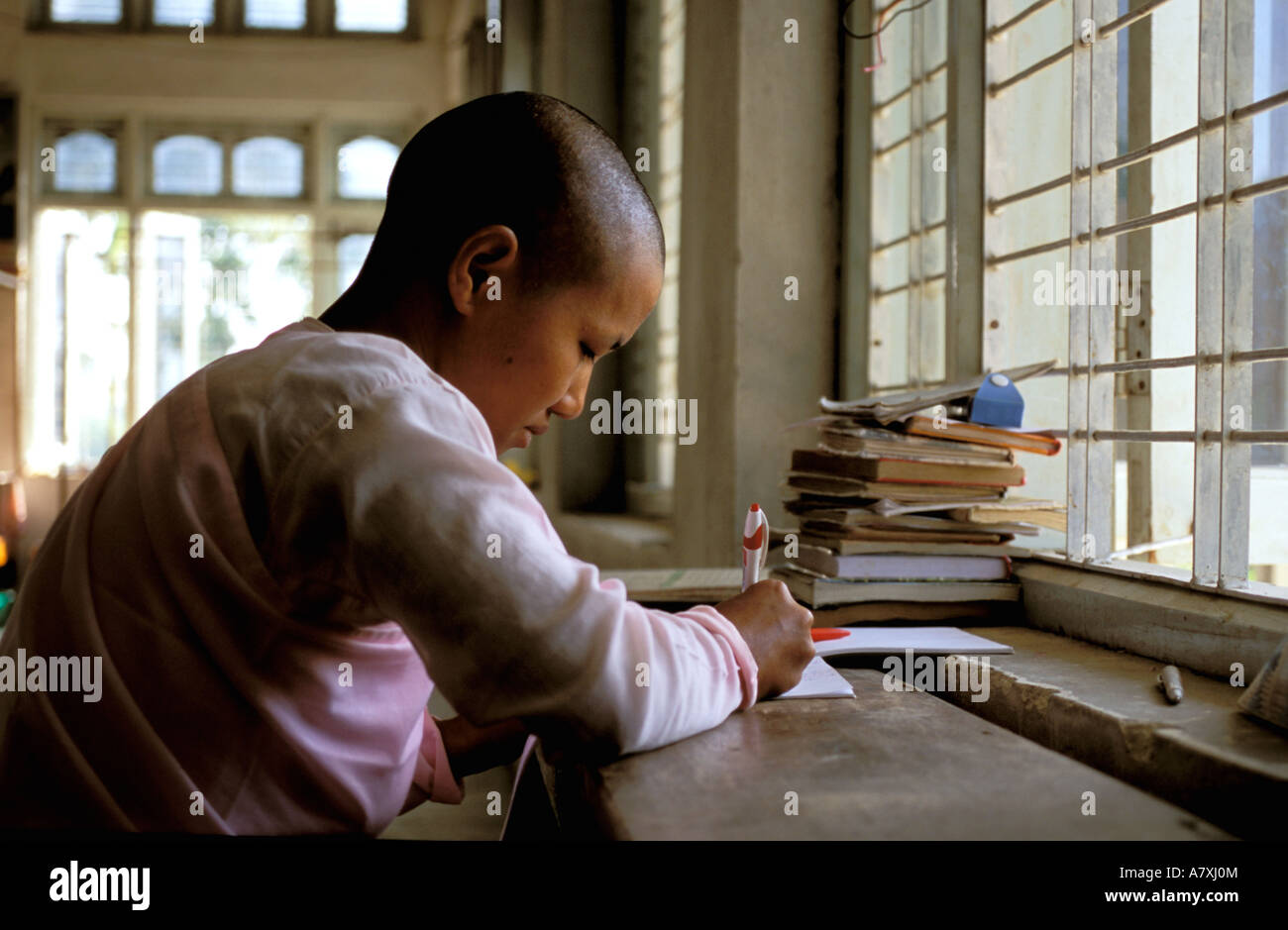 Asia, Myanmar, Mandalay. Young nun studying Stock Photo - Alamy