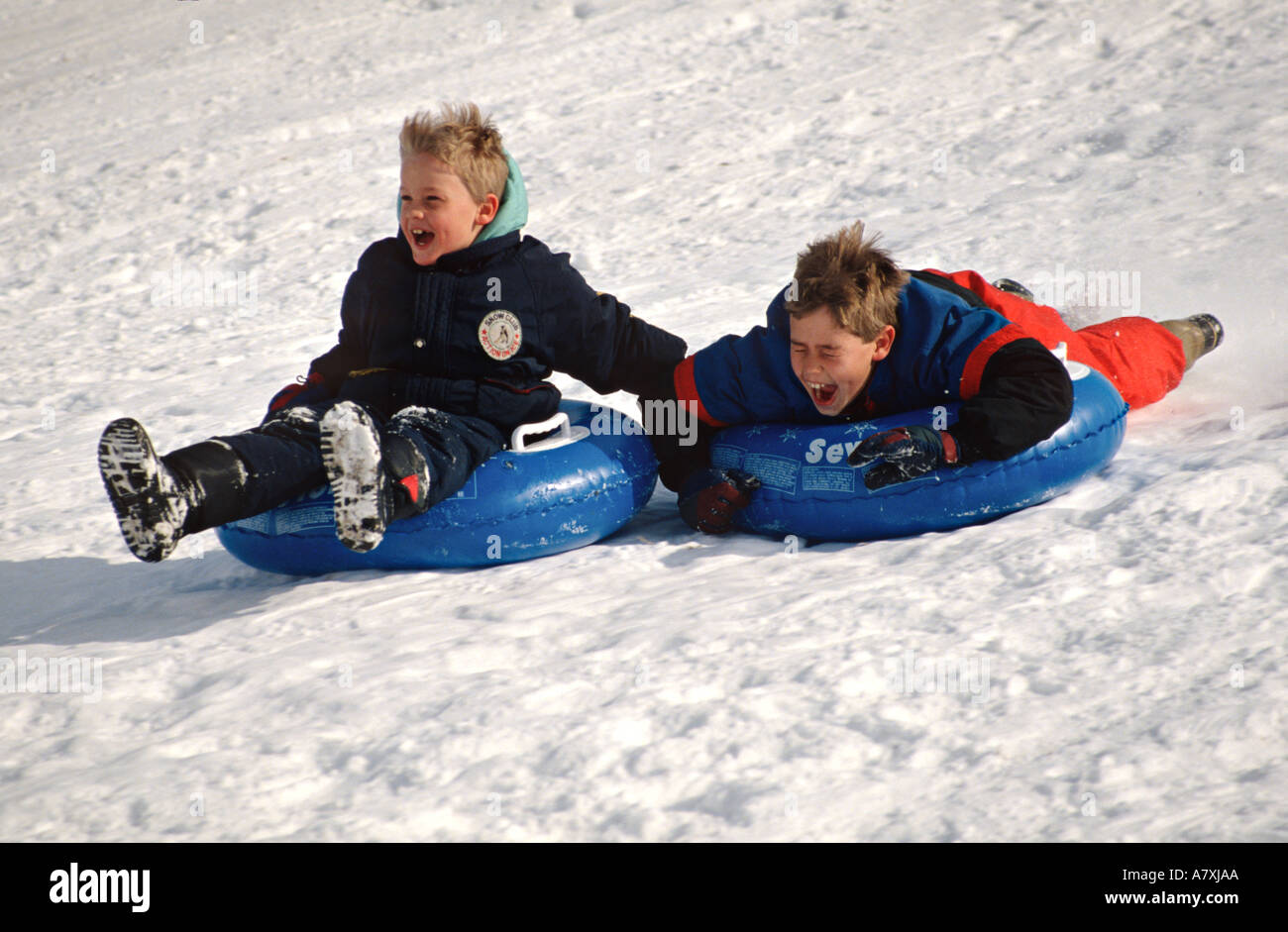 CHILDREN Libertyville Illinois Two young boys sled on inner tubes eyes ...