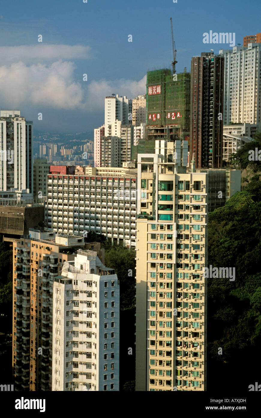 Asia, China, Hong Kong. Hi-rise buildings climb the hillside in the ...