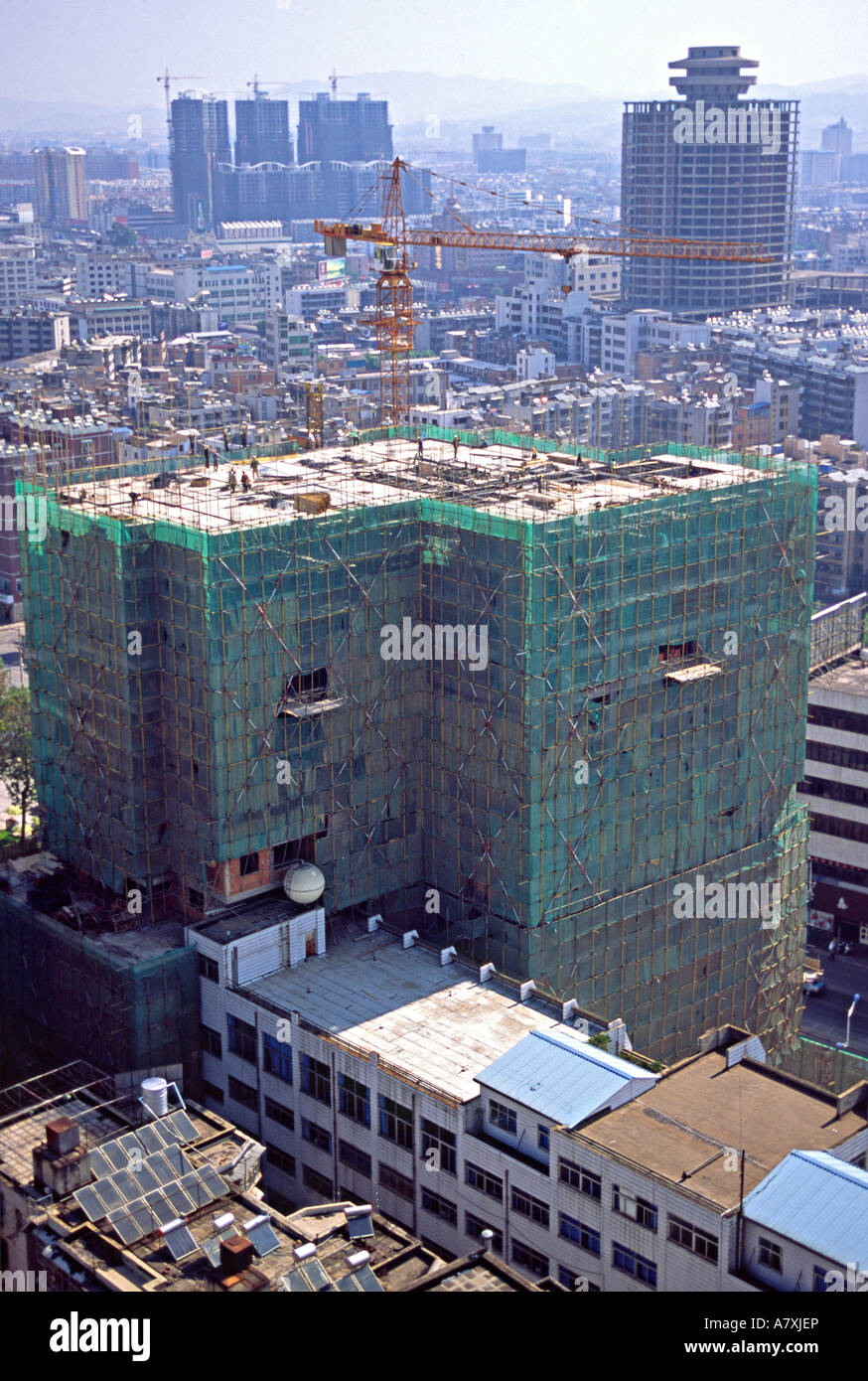 Asia, China, Yunnan, Kunming. Hi-rise building under construction ...