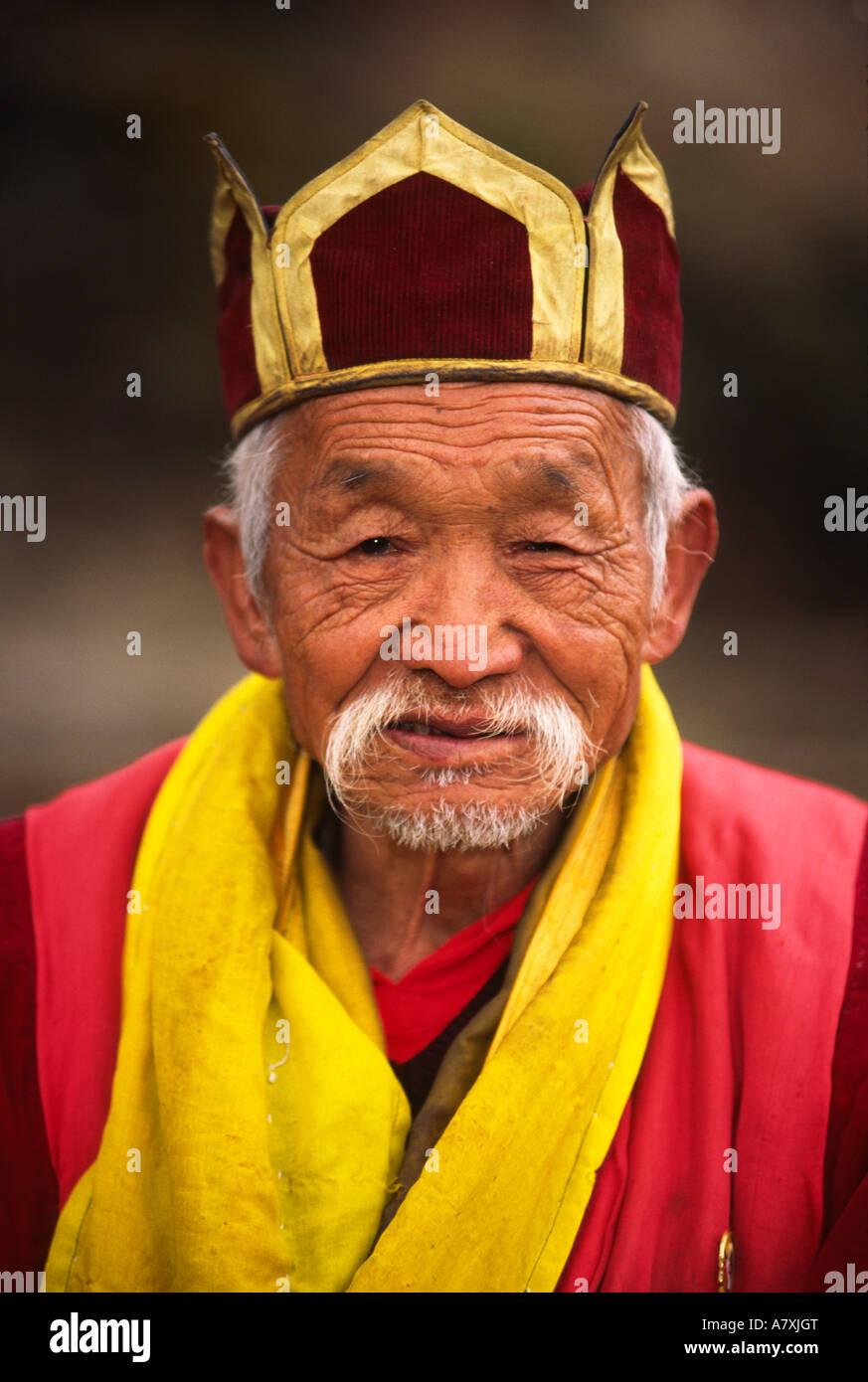 Asia, China, Yunnan Province, Lijiang. Monk of Tibetan Red Hat Buddhist ...
