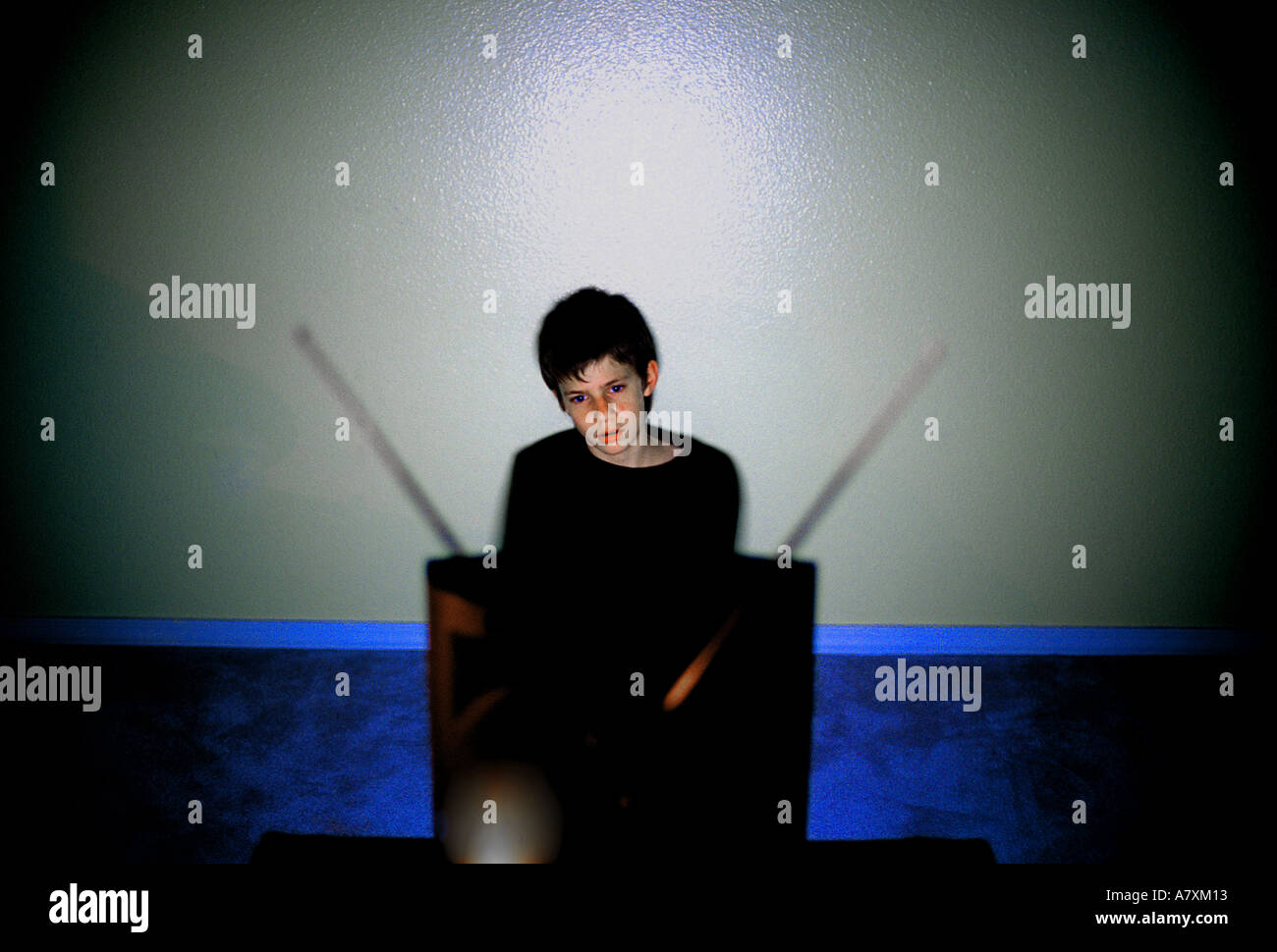 Boy watching television spacing or zoning out Stock Photo - Alamy