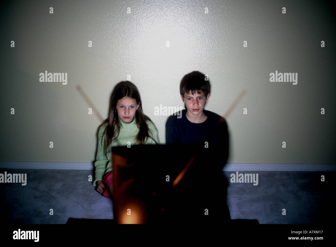 Boy and girl watching television spacing or zoning out Stock Photo - Alamy