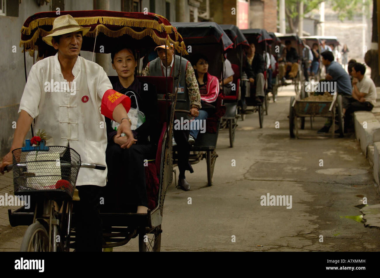 Chinese rickshaws driving through the narrow streets in Hutong (old ...