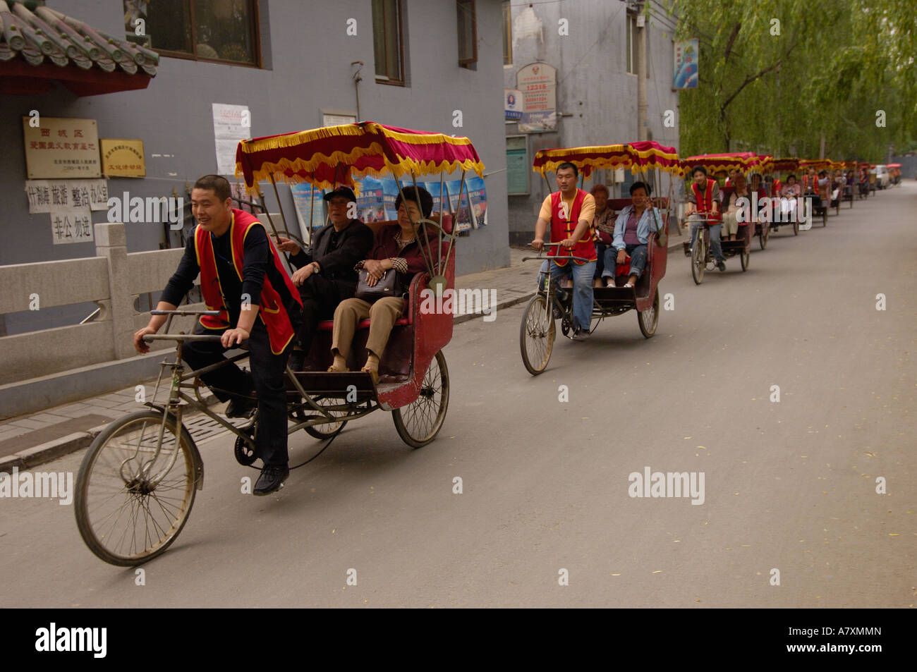 Chinese rickshaws driving through the narrow streets in Hutong (old ...