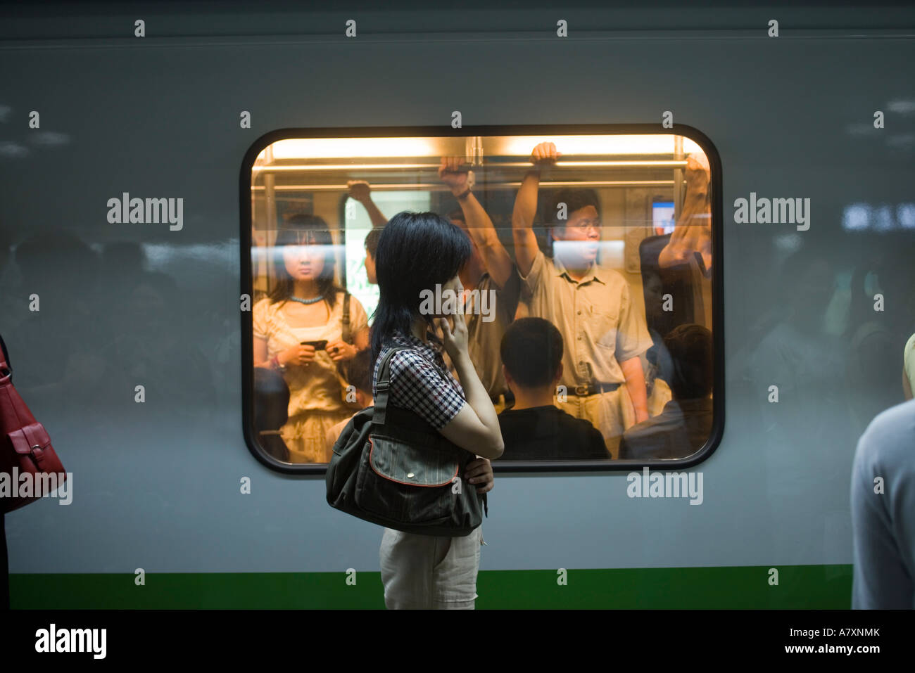 Asia, China, Shanghai, Passenger waits for crowded Metro subway train ...