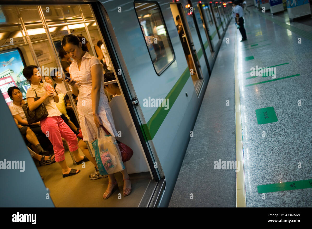 Asia, China, Shanghai, Passengers on crowded Metro subway train during ...