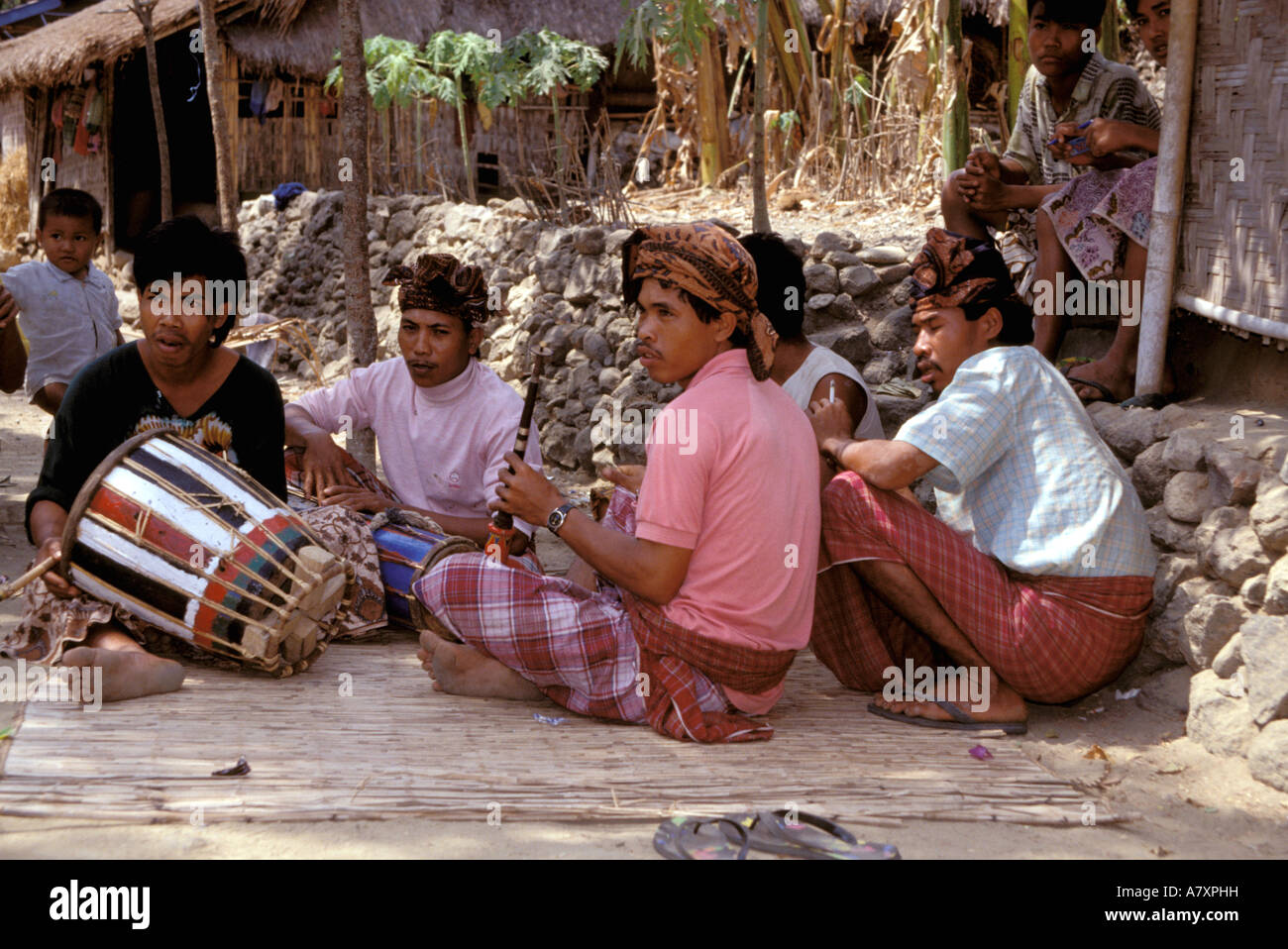 Asia, Indonesia, Lombok, Sasak Village. Locals playing traditional ...
