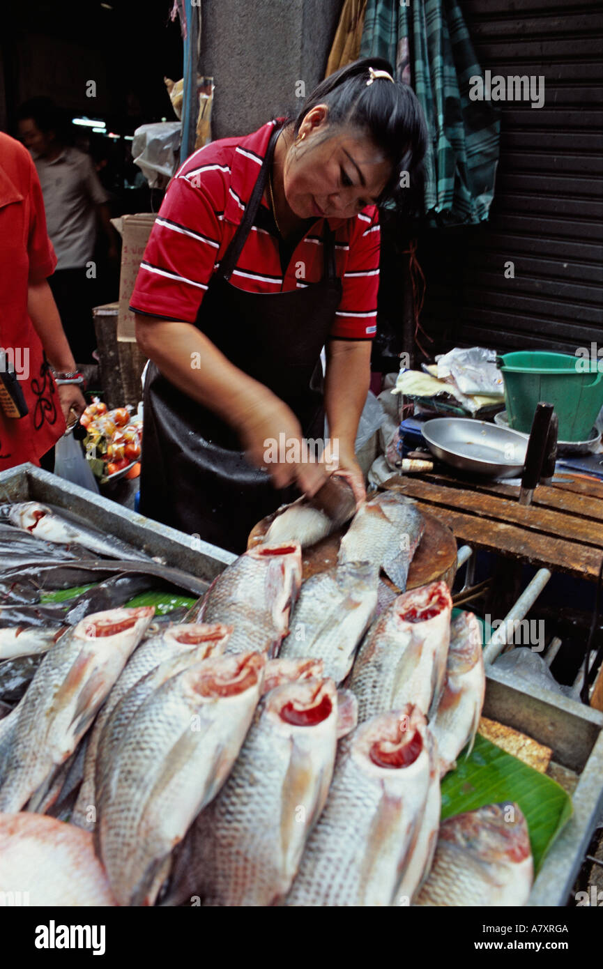 Woman butchers fresh fish at seafood market, Chiang Mai, Thailand Stock ...