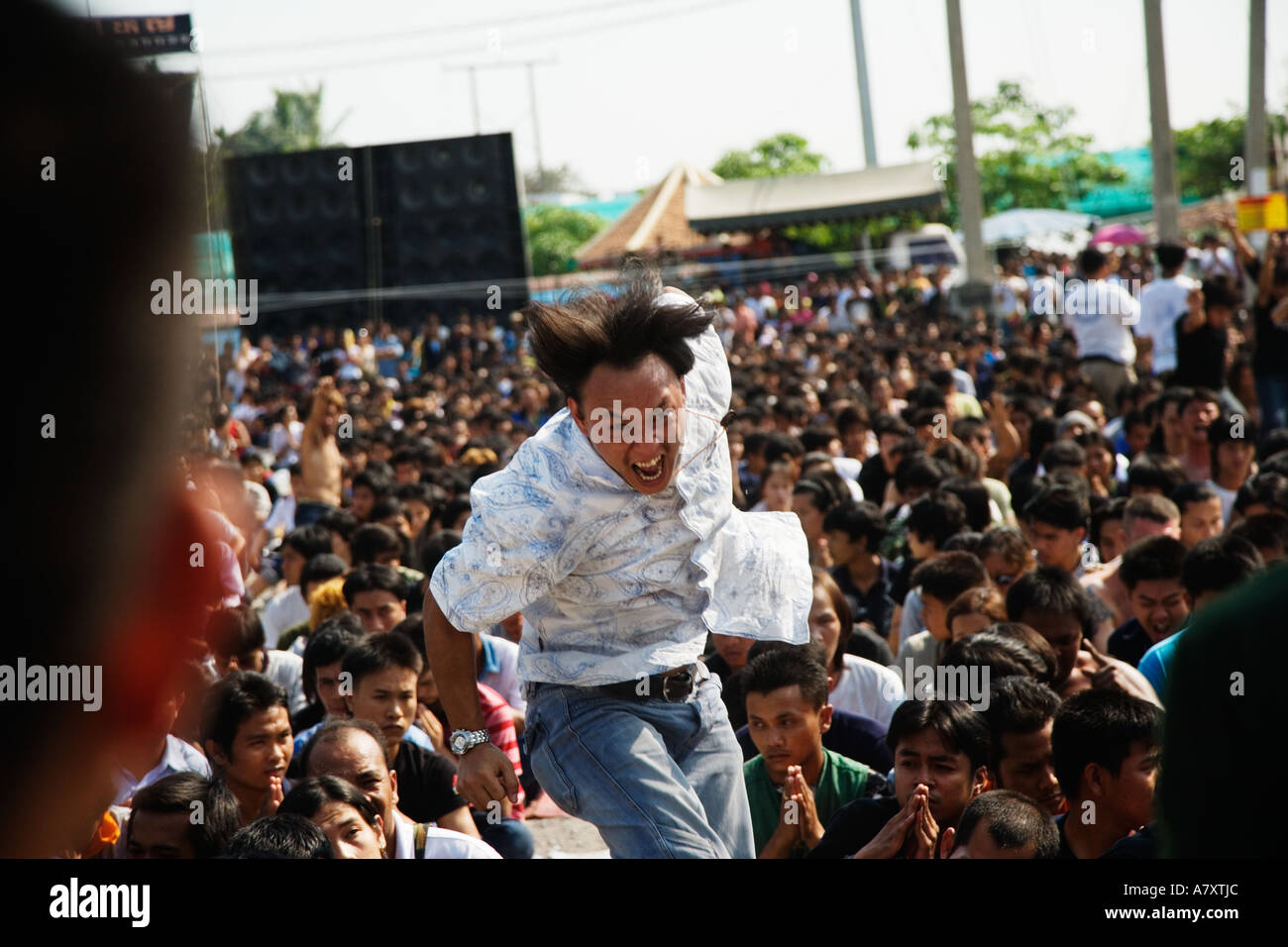 Man in trance charges the stage at the Wat Bang Phra Tattoo Festival ...