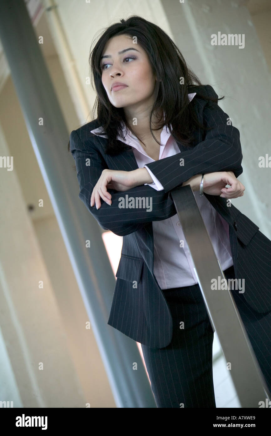 Woman leaning on a rail Stock Photo - Alamy