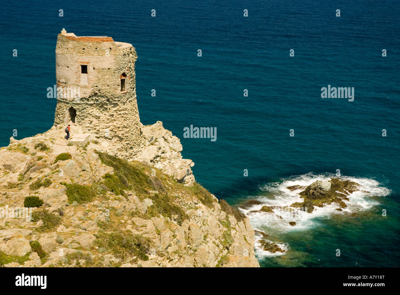 Europe, France, Corsica, Cap Corse. Hiker approaches 16th century ...