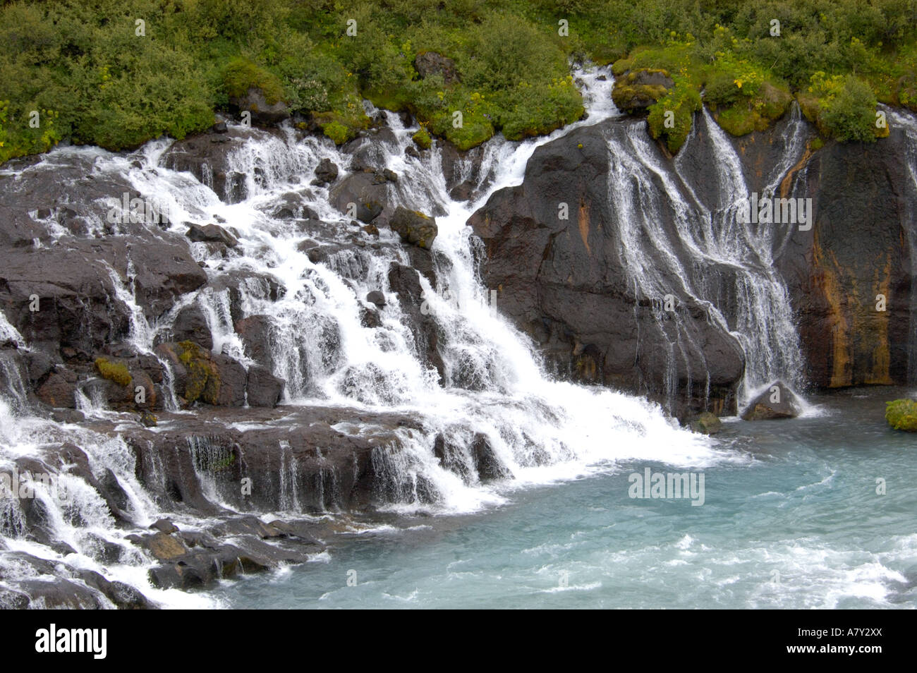 Iceland, Hraunfossar waterfall - Water flowing through layers of lava ...