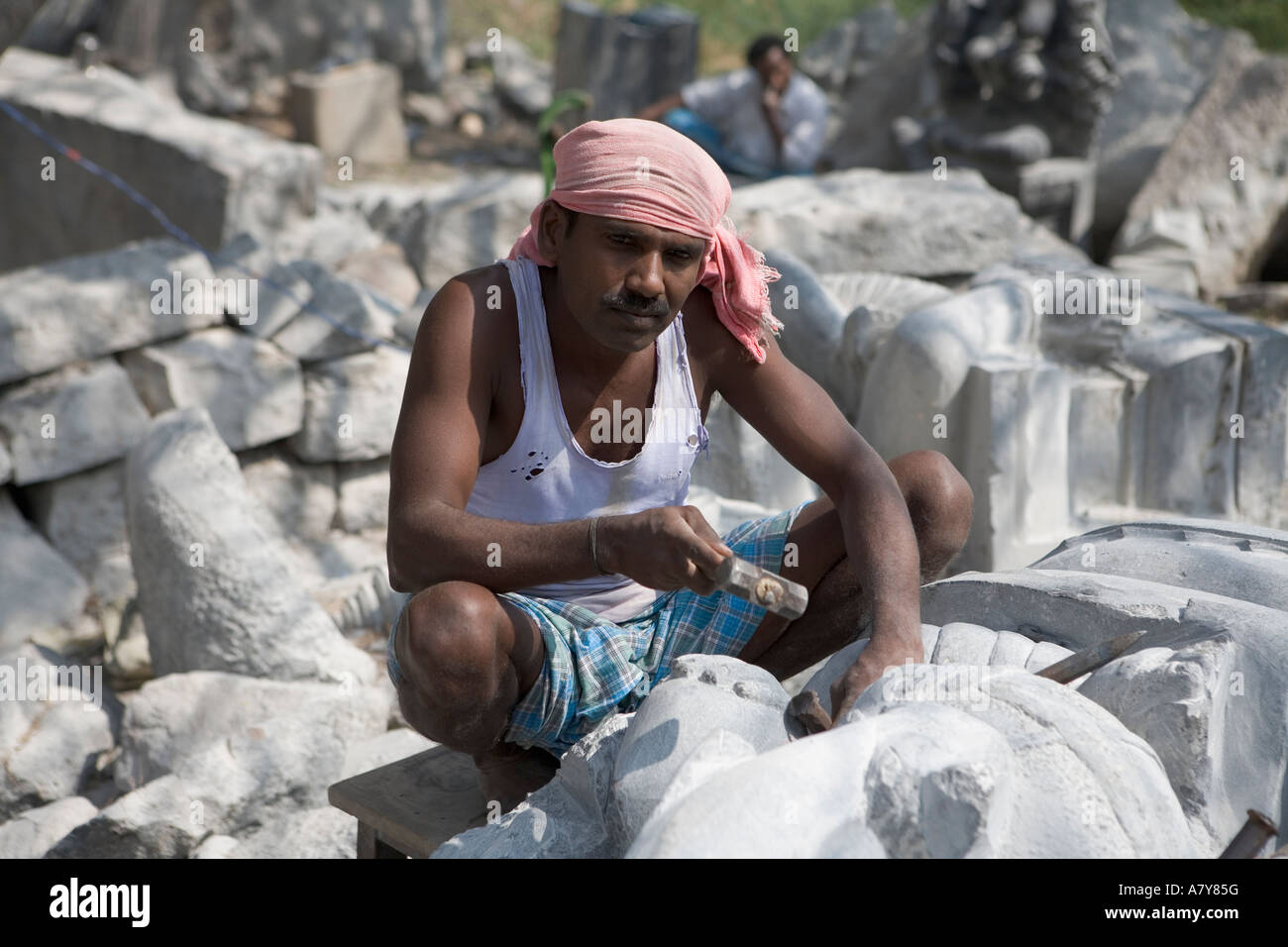 Man carves granite figure in the traditional way Stock Photo - Alamy