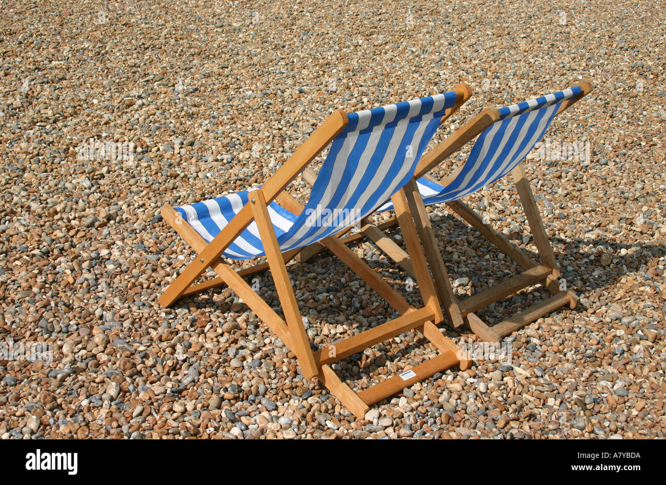 Two deck chairs empty on Brighton beach Stock Photo - Alamy