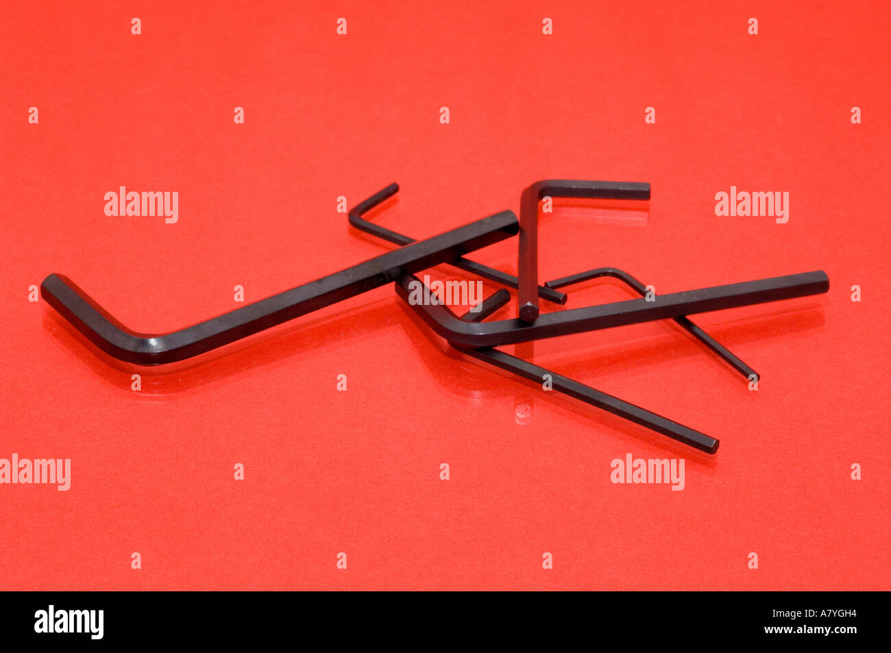 Small Allen keys on a red background Stock Photo - Alamy
