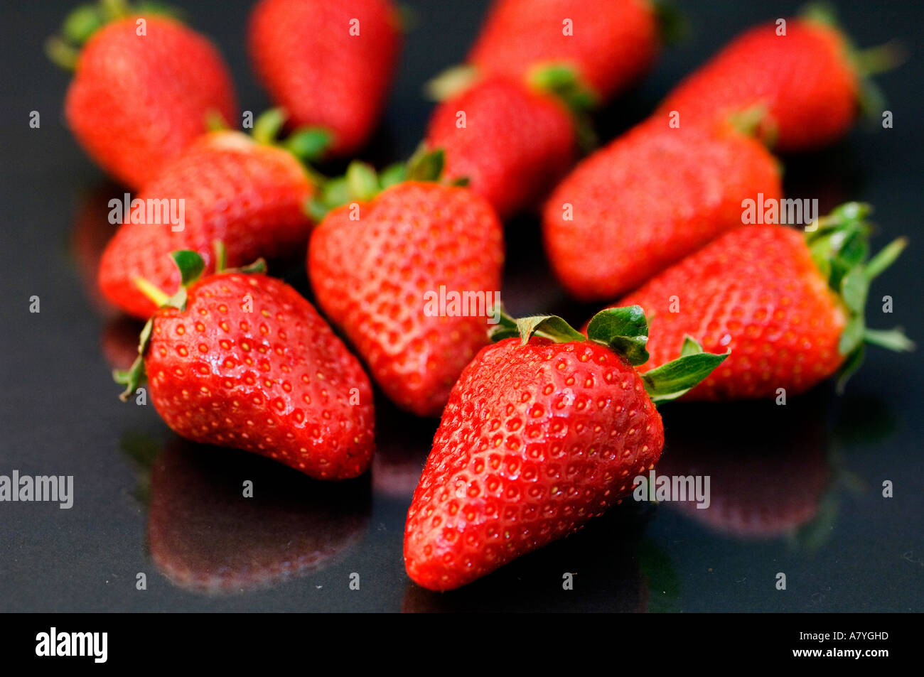 Strawberries on a black background with reflection Stock Photo - Alamy